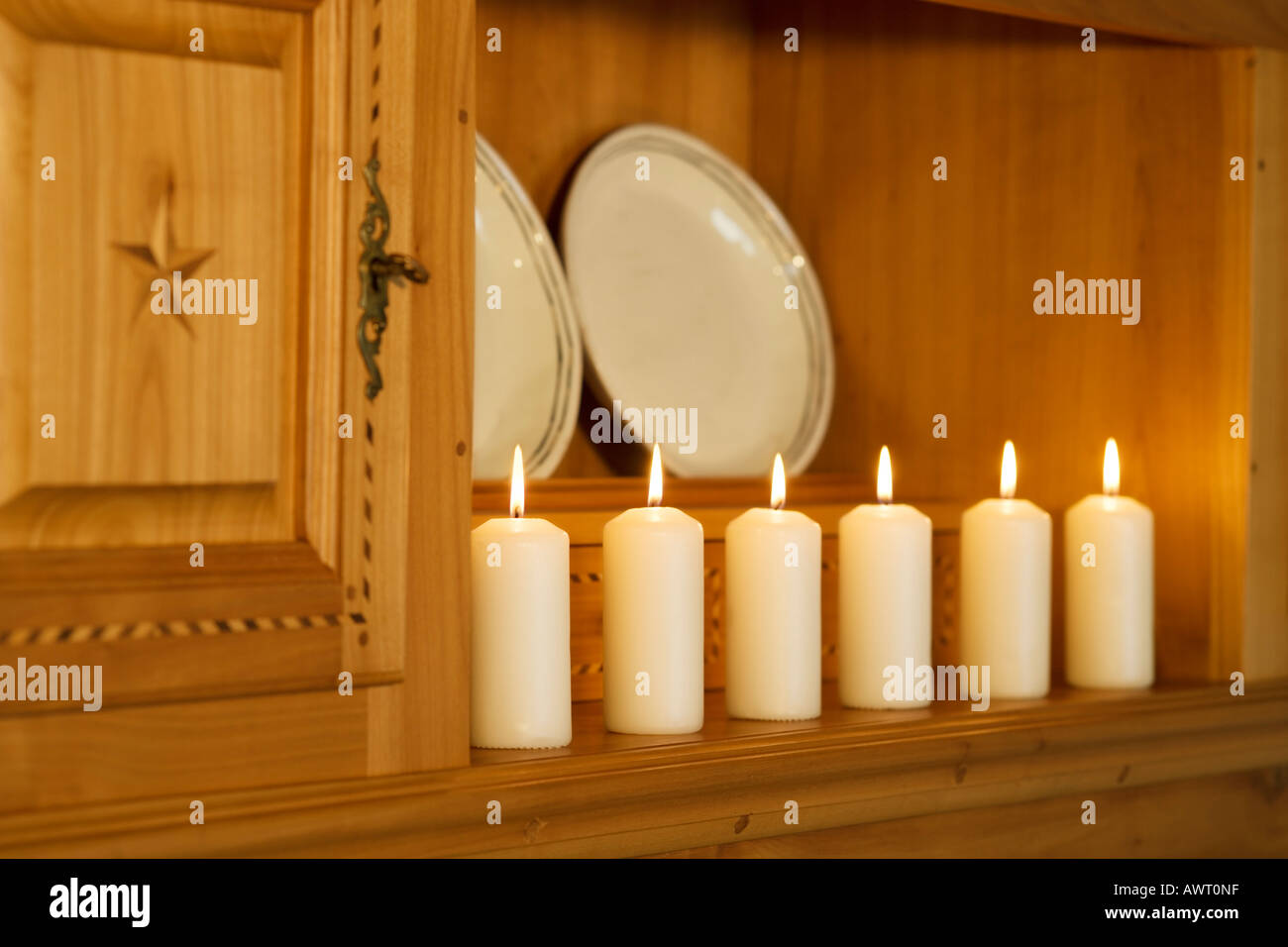 Row of flickering white candles hi-res stock photography and images - Alamy