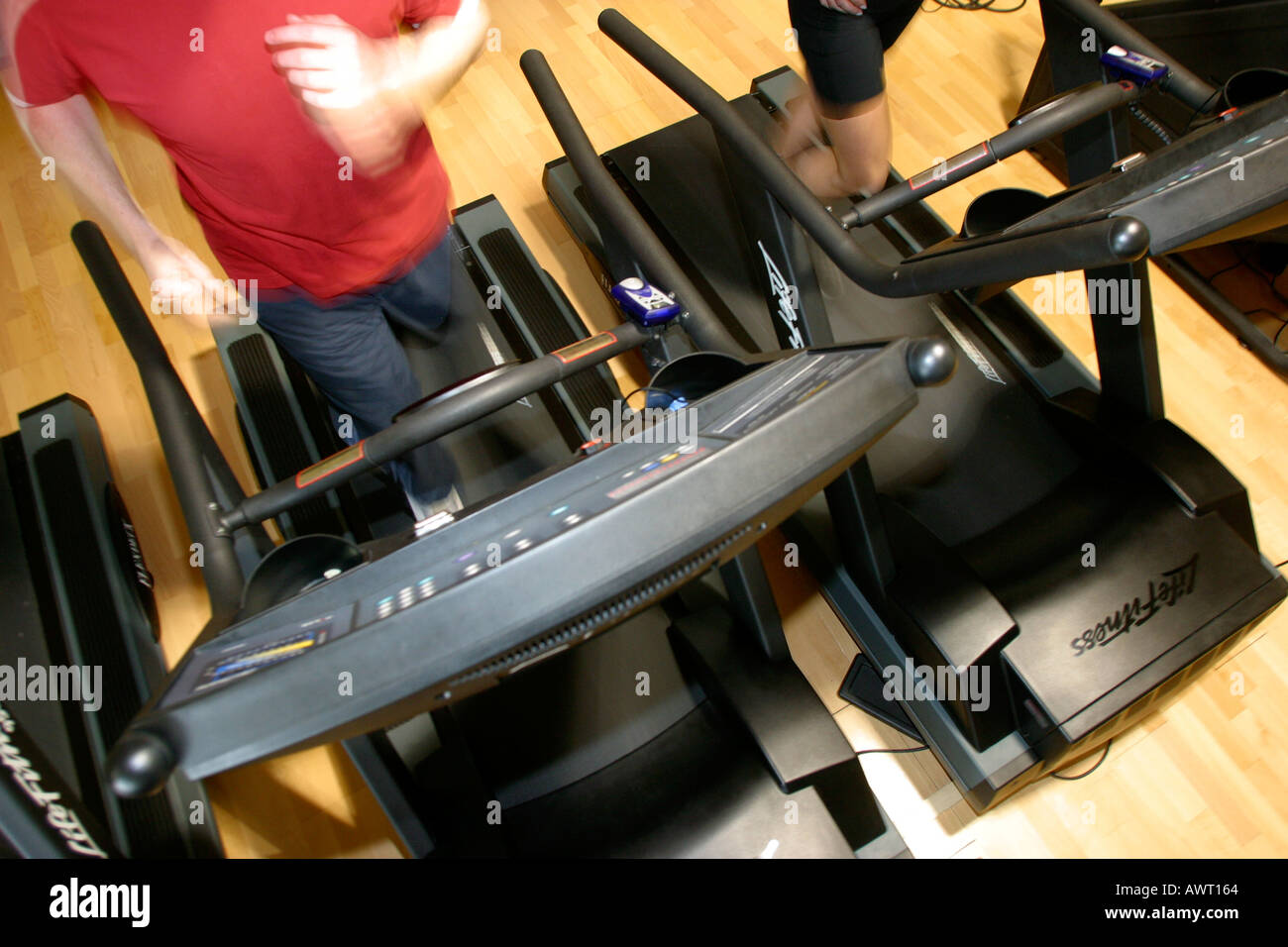 MAN AND WOMEN RUNNING ON RUNNING MACHINE ACTION BLUR EFFECT FROM ABOVE ...