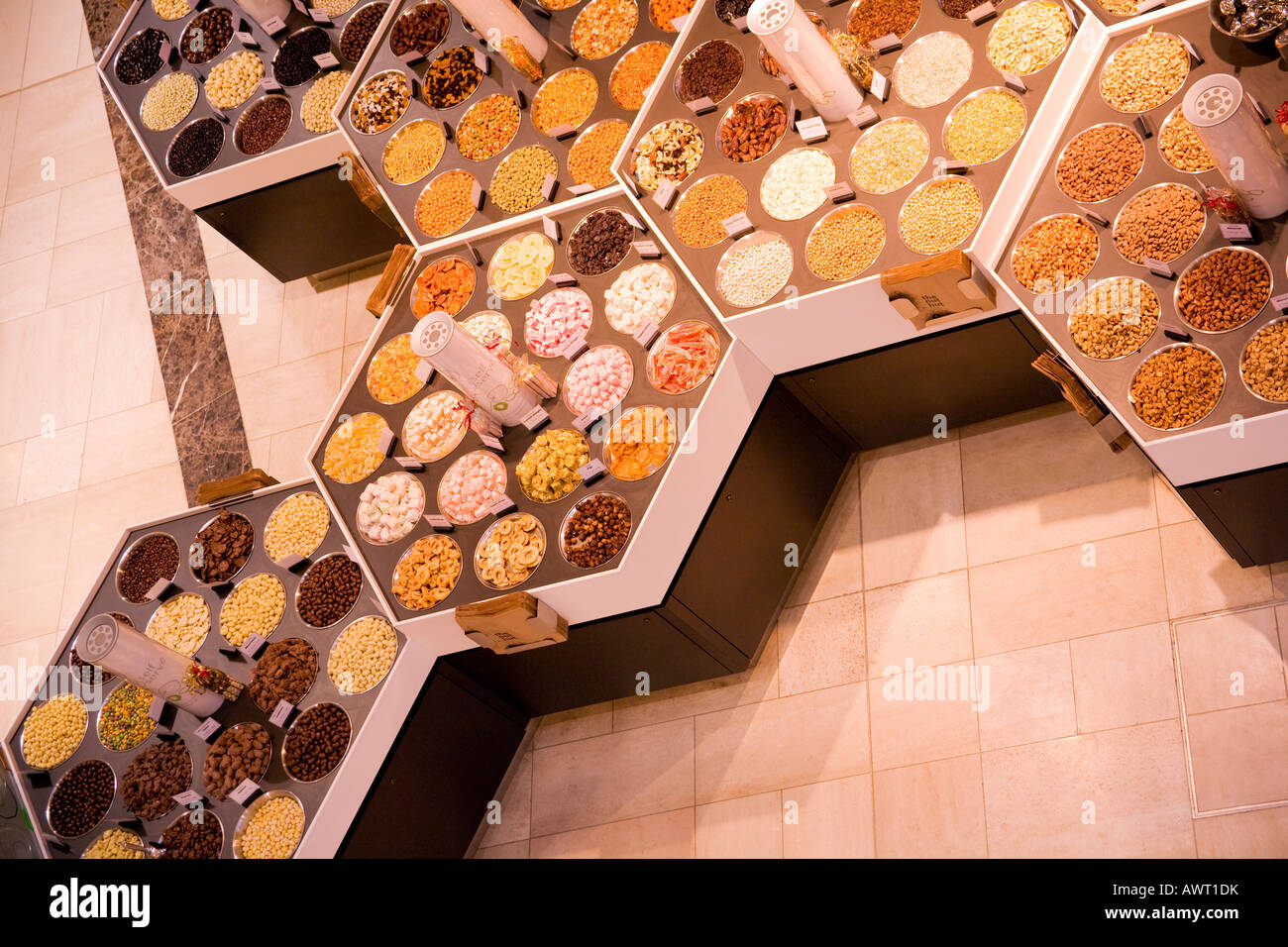 Bowls of nuts, dried fruit and snack food on display as seen from above ...