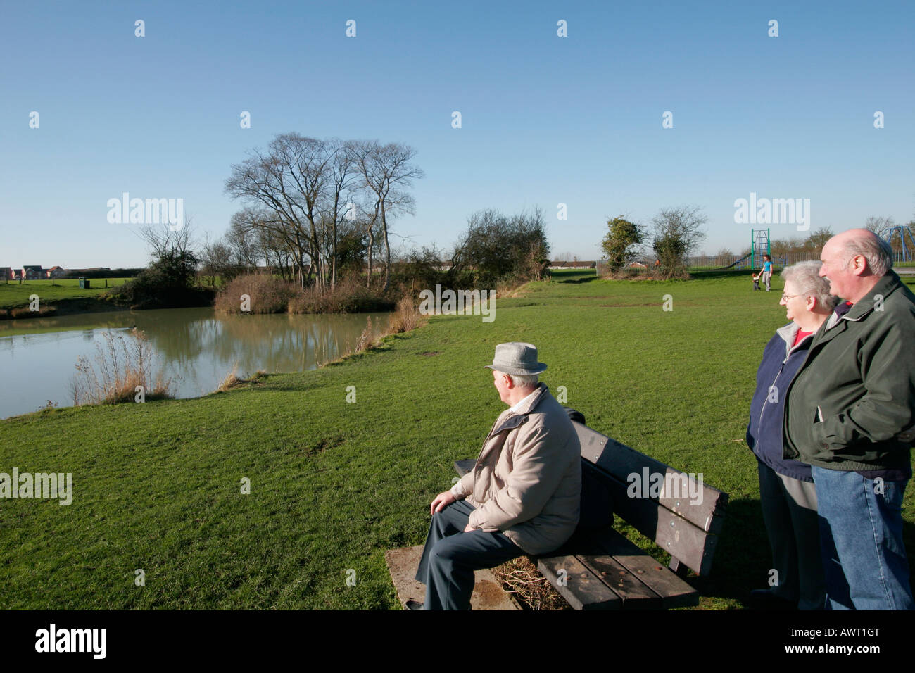 A group of elderly people gather at a pond Stock Photo - Alamy