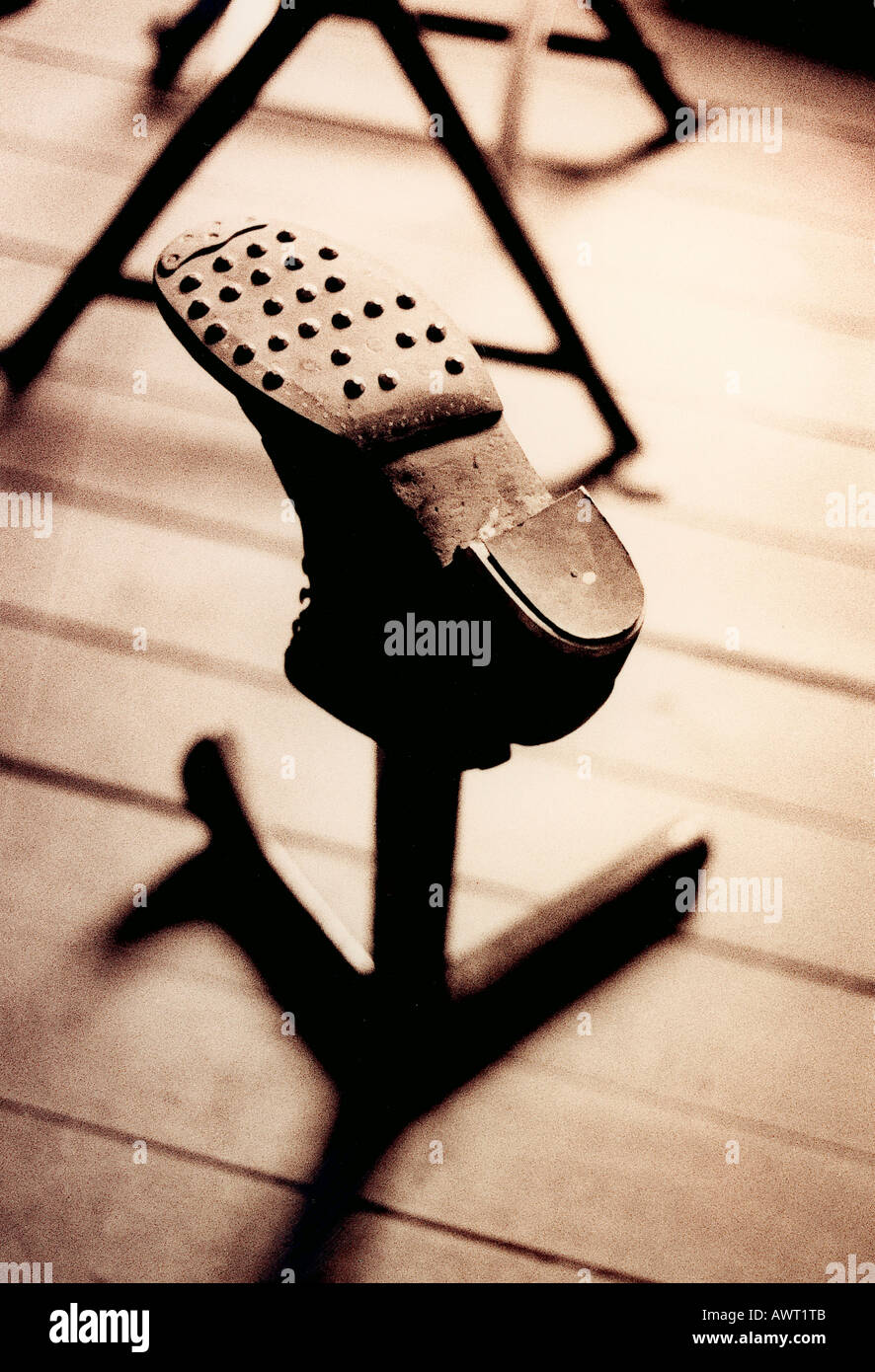 Old shoemaker workshop, shoe with nailed sole on a three-legged ...