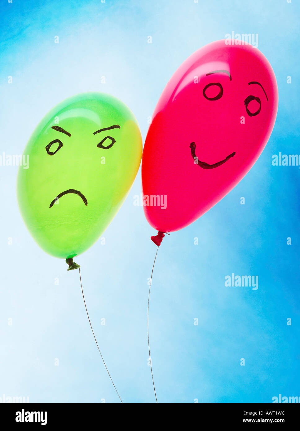Two balloons with a funny and an angry face Stock Photo - Alamy