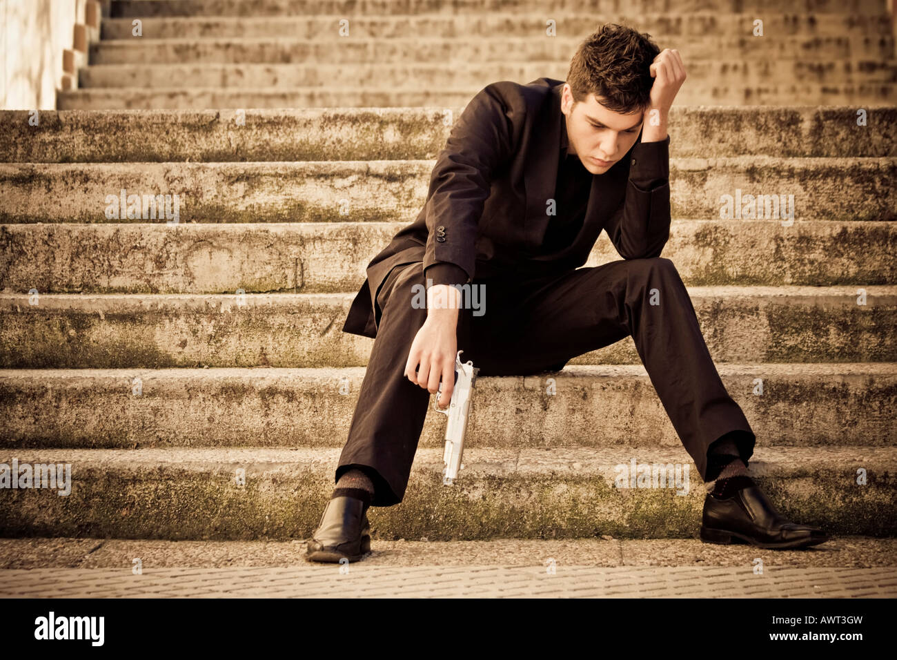 Man with gun on stairs Stock Photo - Alamy