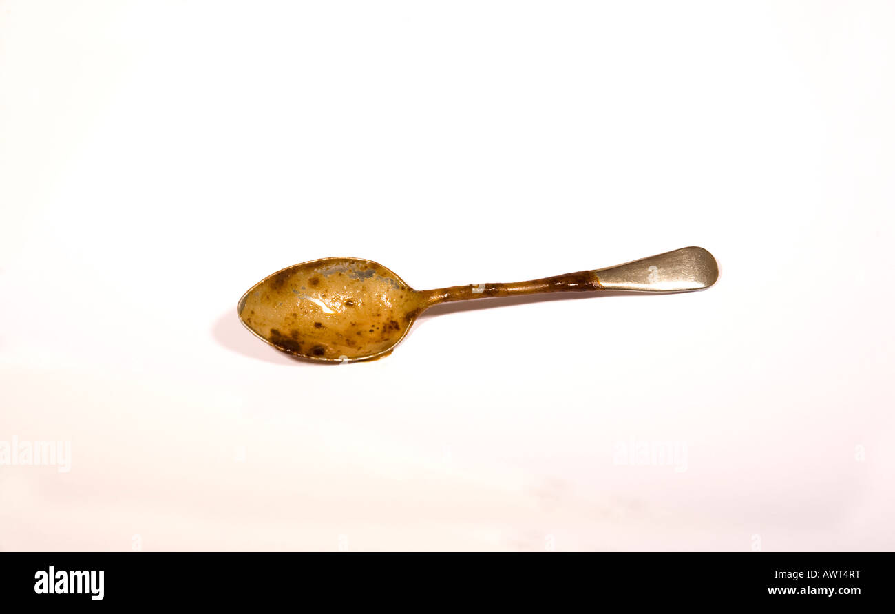 Unwashed tea spoon used to stir coffee and milk Stock Photo - Alamy