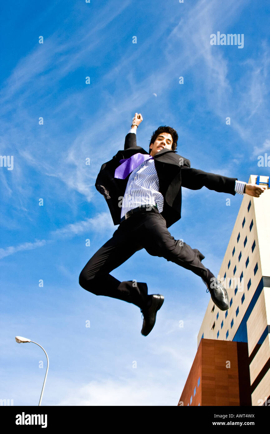 Jumping businessman over urban background Stock Photo - Alamy