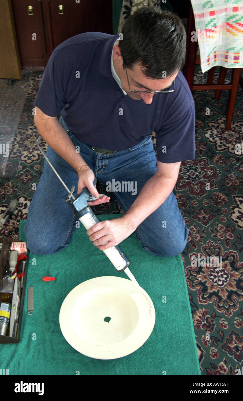 An Electrician installing a ceiling light fitting Stock Photo - Alamy