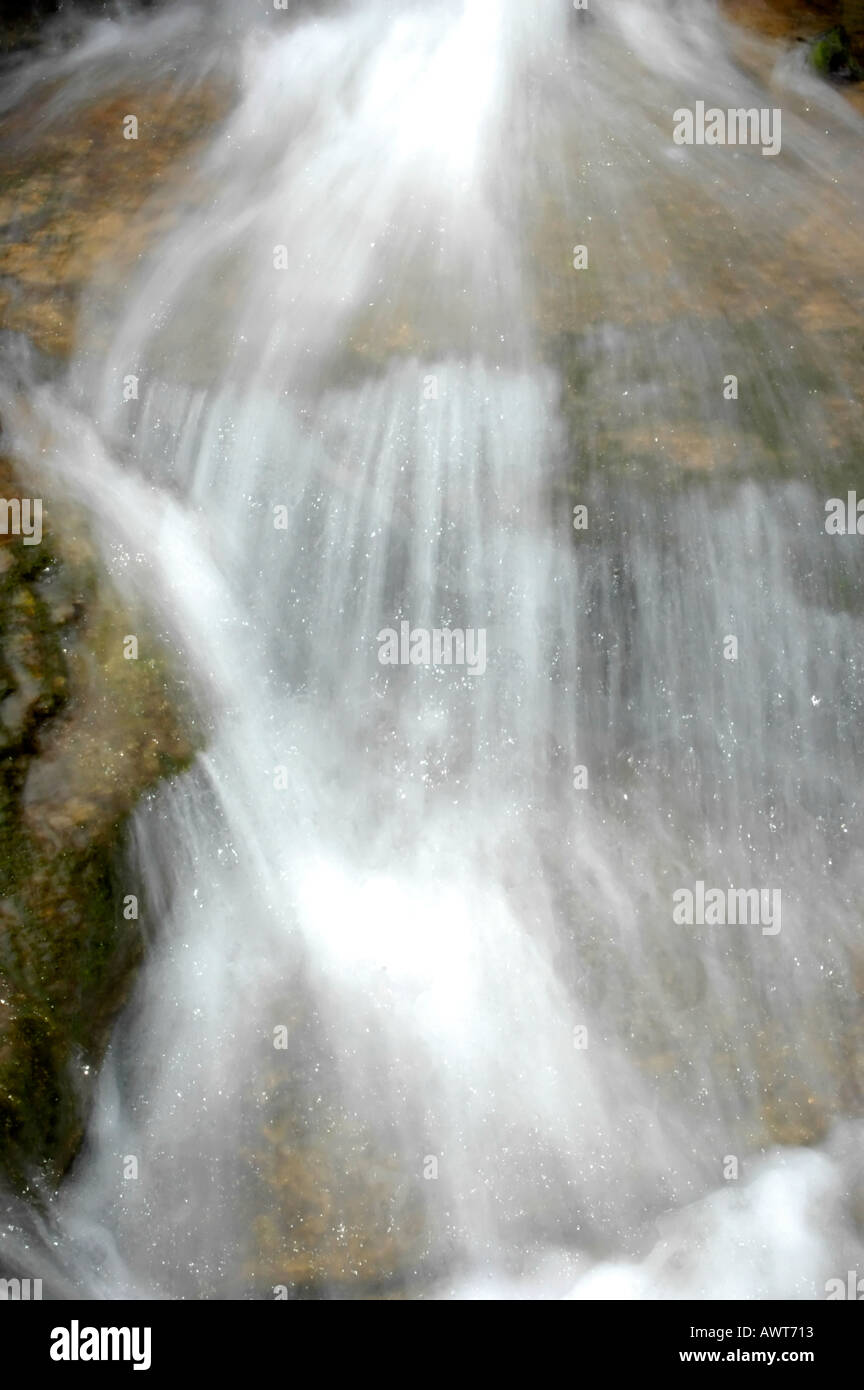 Water cascading over stones on a crystal clear stream Stock Photo - Alamy