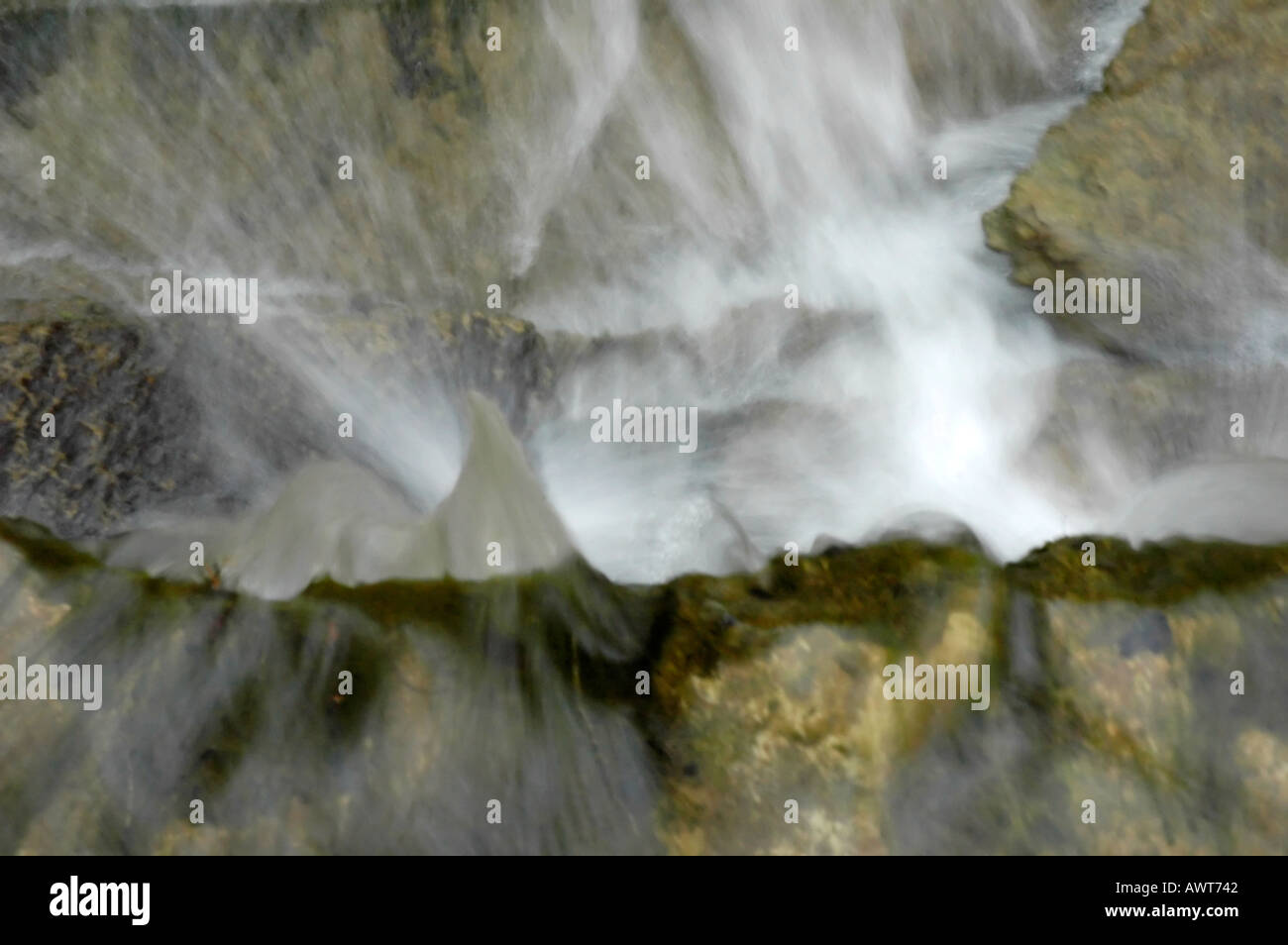 Water cascading over a small waterfall as viewed from above the rim ...