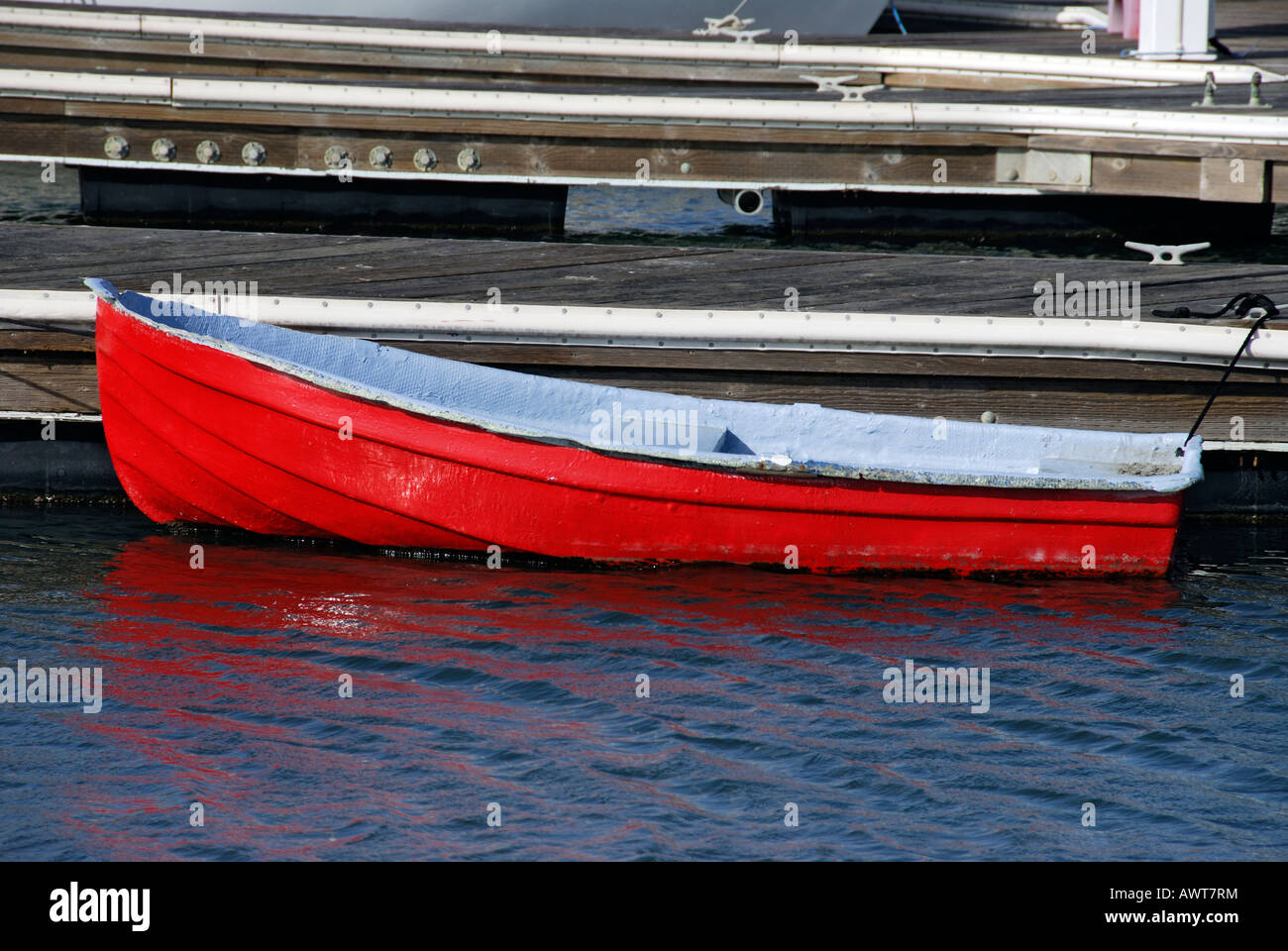 "red dinghy boat on jetty Stock Photo - Alamy