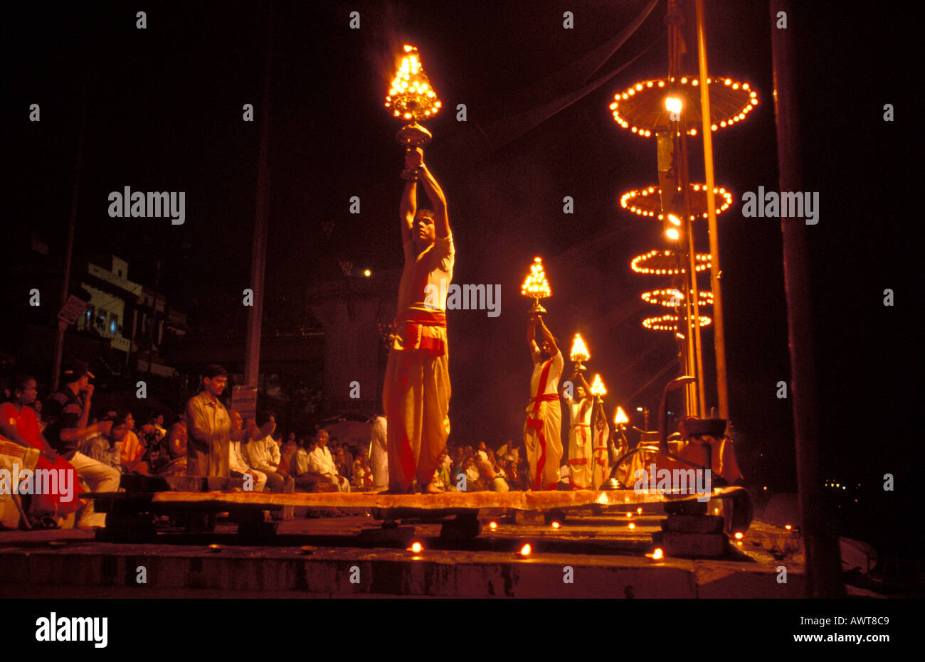 India Varanasi Hindu priest perform an Arti worship ceremony at night ...
