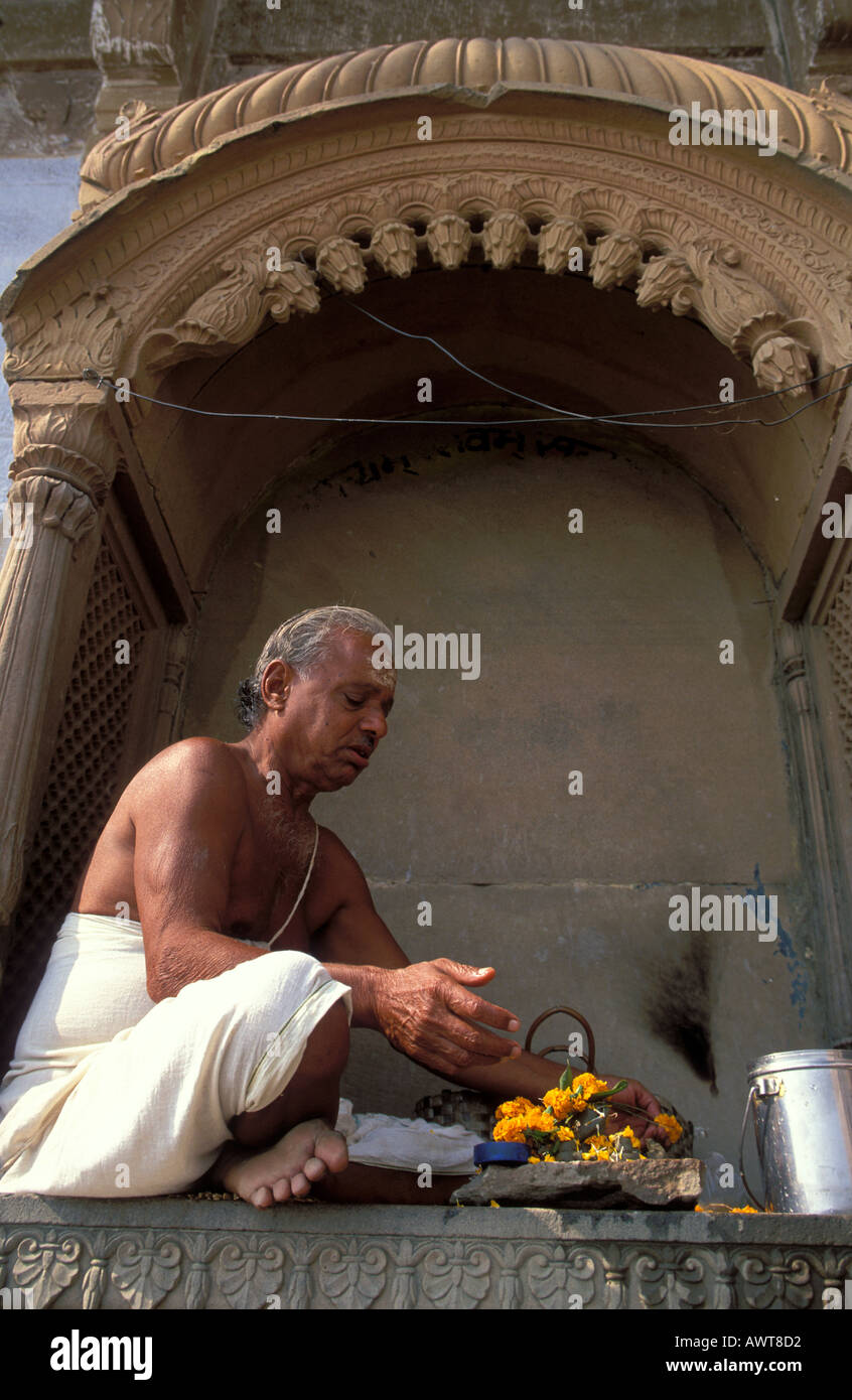 India Varanasi Hindu priest performing a Puja religious ritual ceremony ...