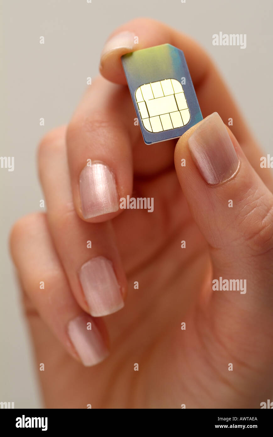 Mobile Phone SIM Card Held Between the Fingers of a Female Stock Photo ...
