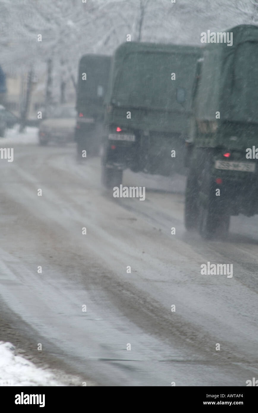 Military Lorries Driving in Convoy on a European Road During Winter ...