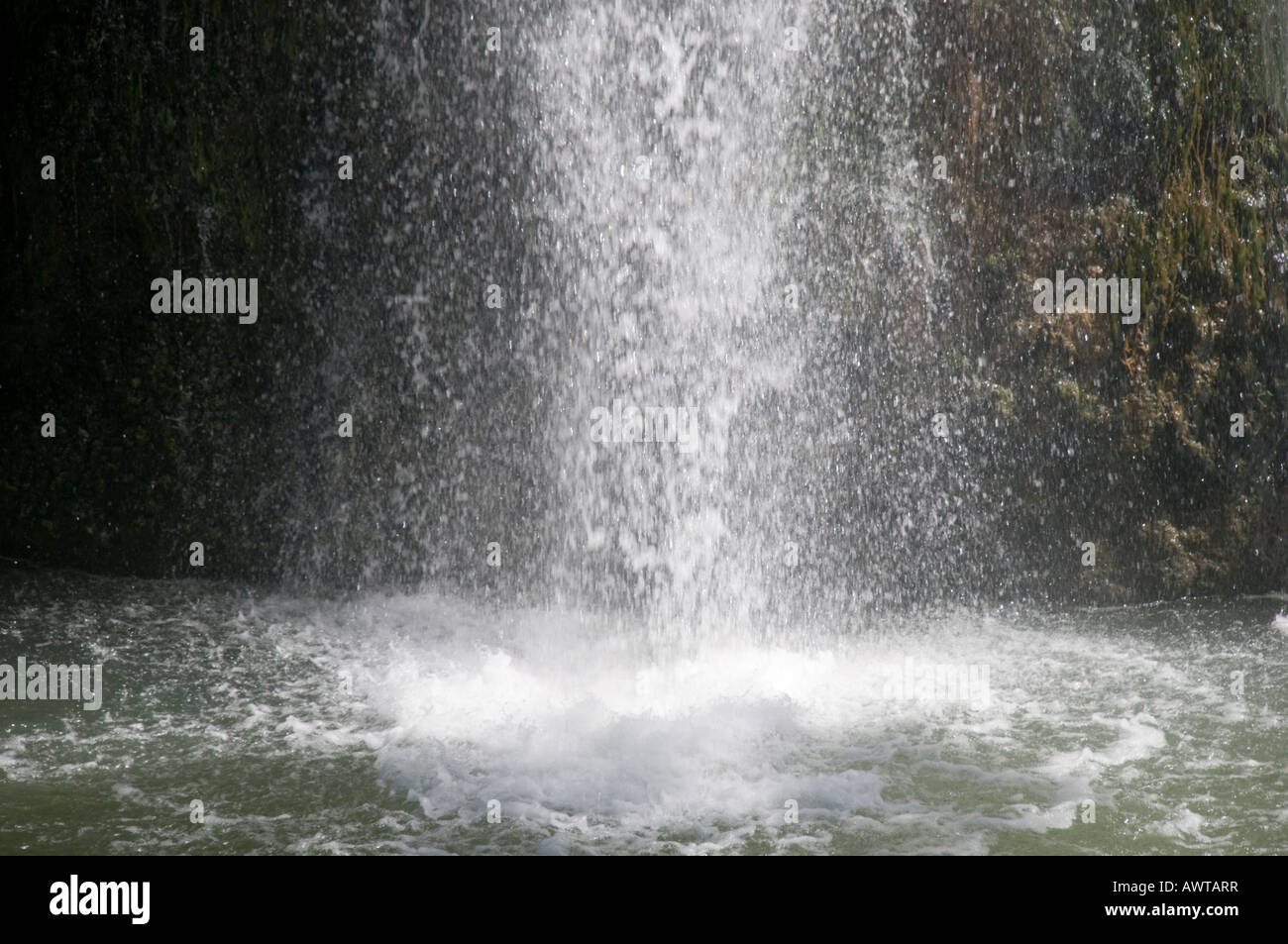 A natural waterfall Conceptual close up of the water splashing into a ...