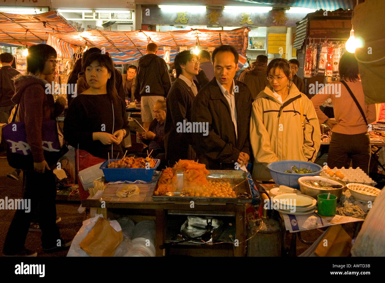 dh Temple street market JORDAN HONG KONG Customers at snack food stall ...
