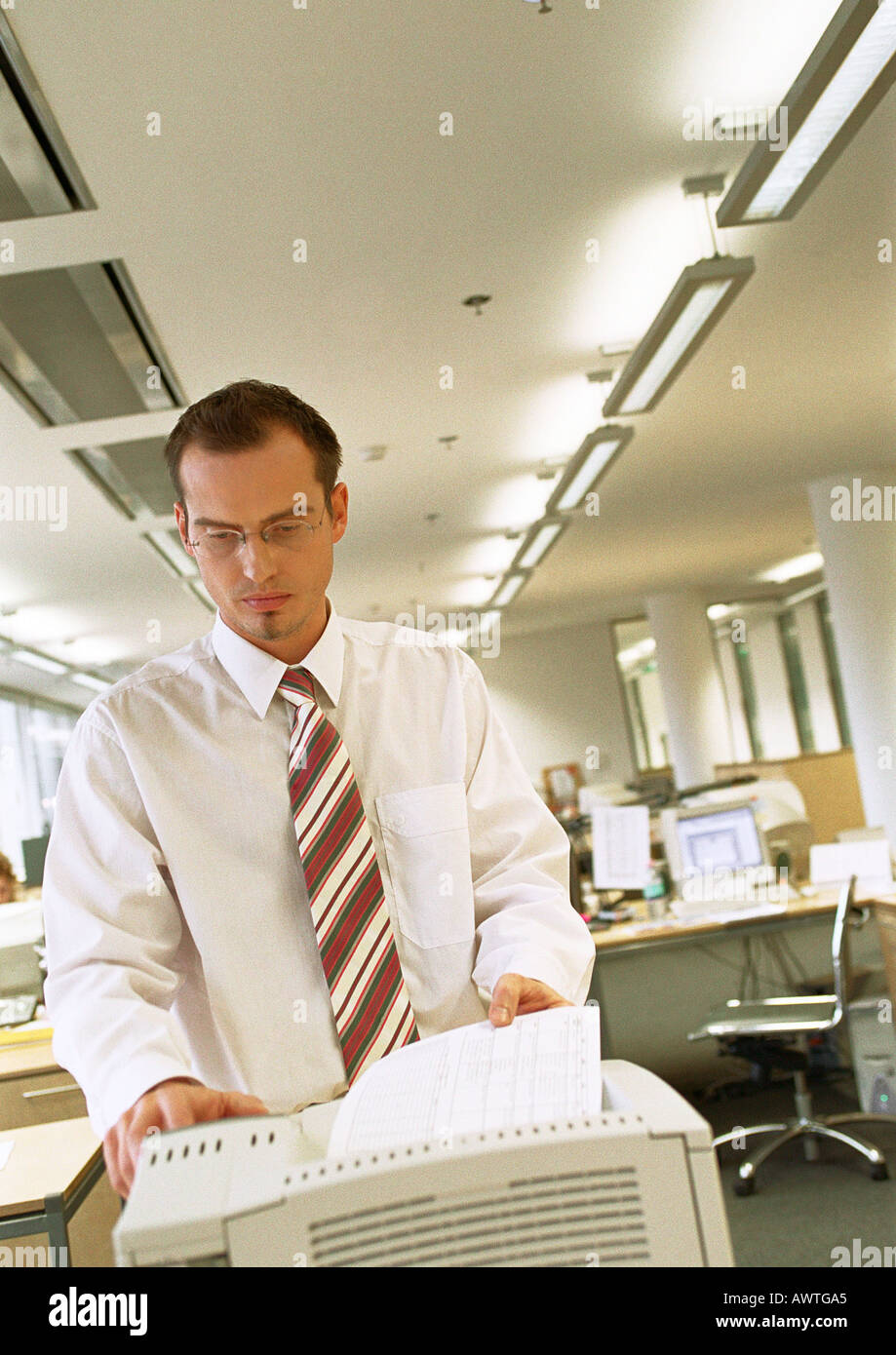Businessman using copy machine Stock Photo - Alamy