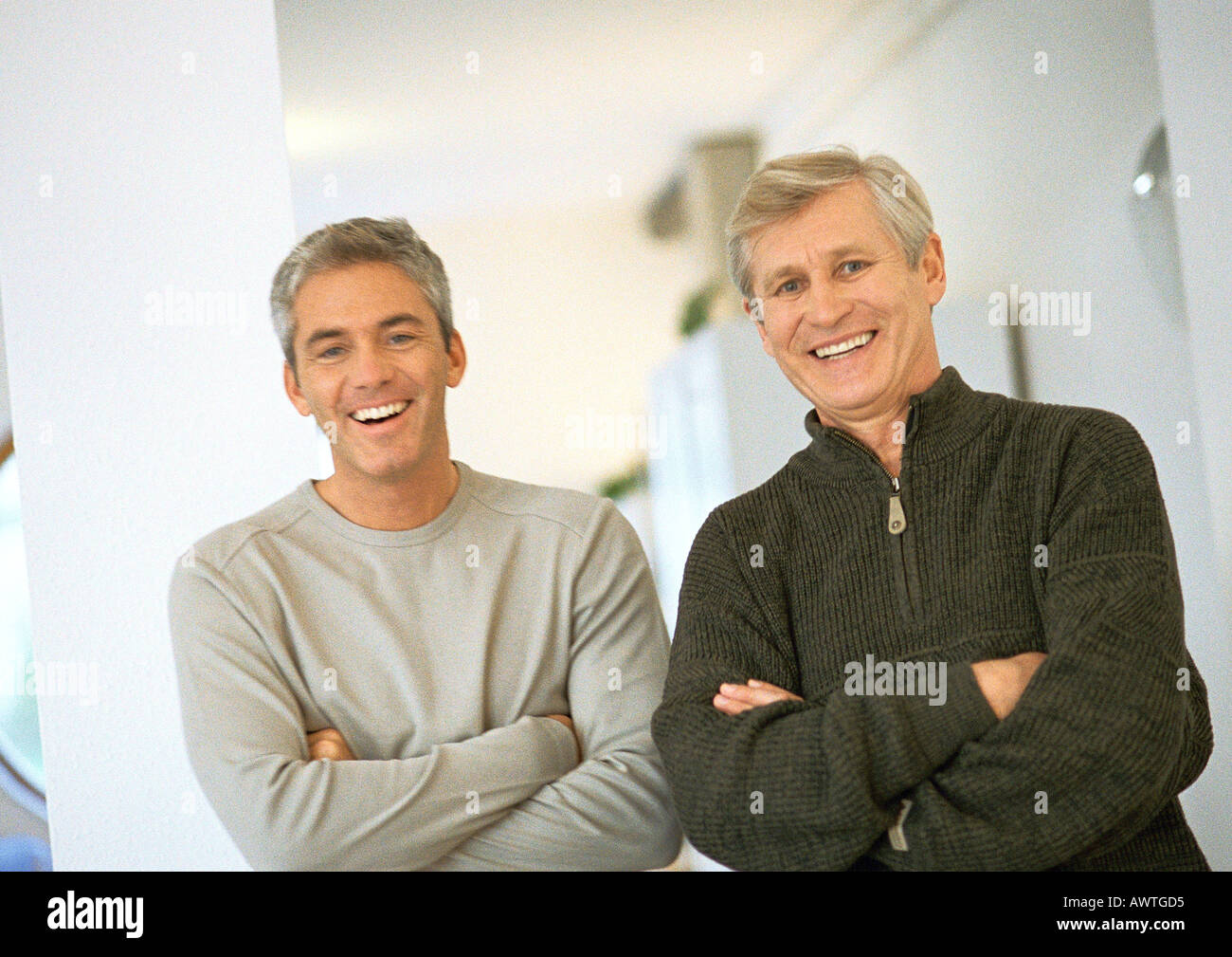 Two men standing crossing arms hi-res stock photography and images - Alamy