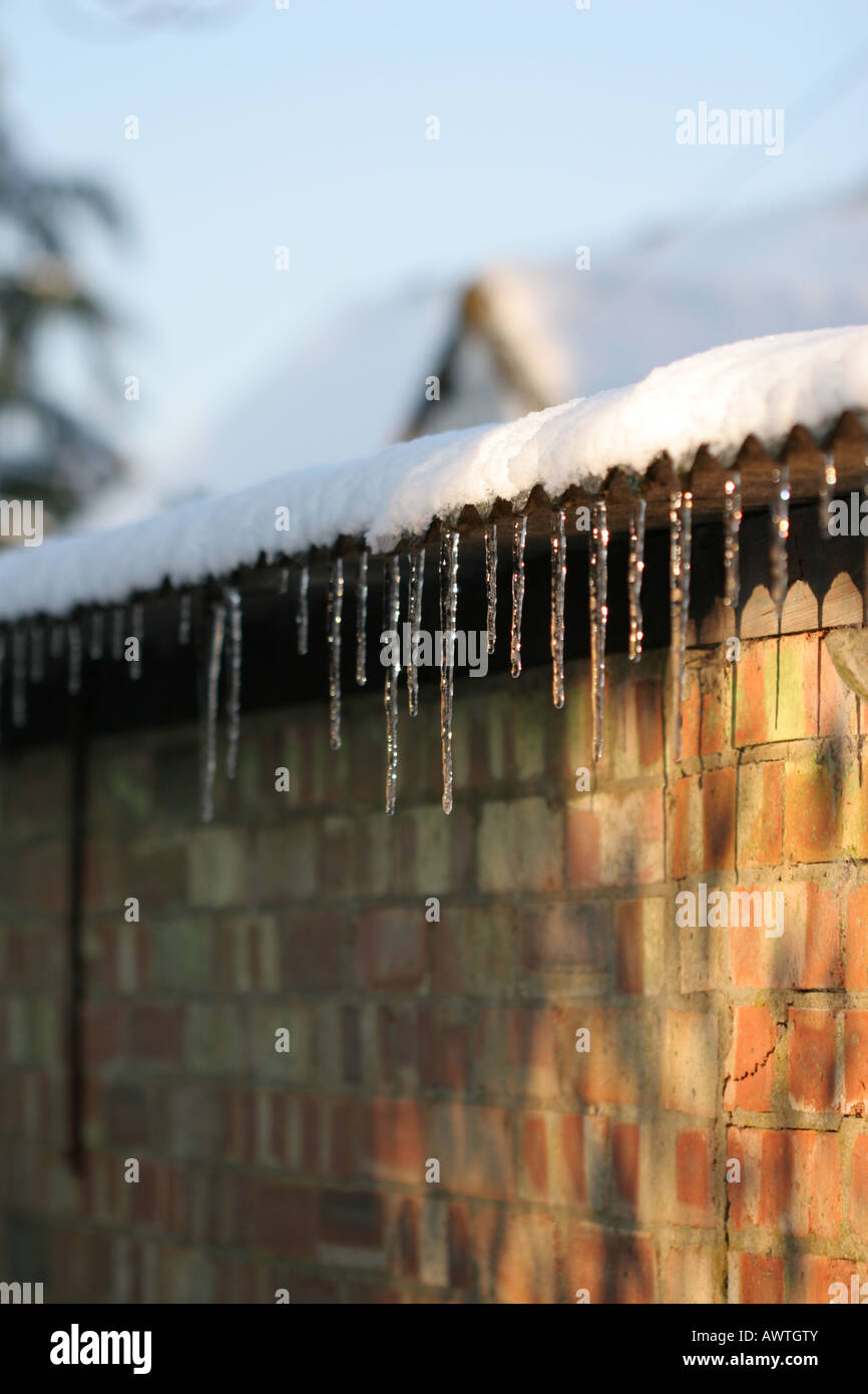 Icicles hanging from snow topped corrugated metal roof in winter Stock ...