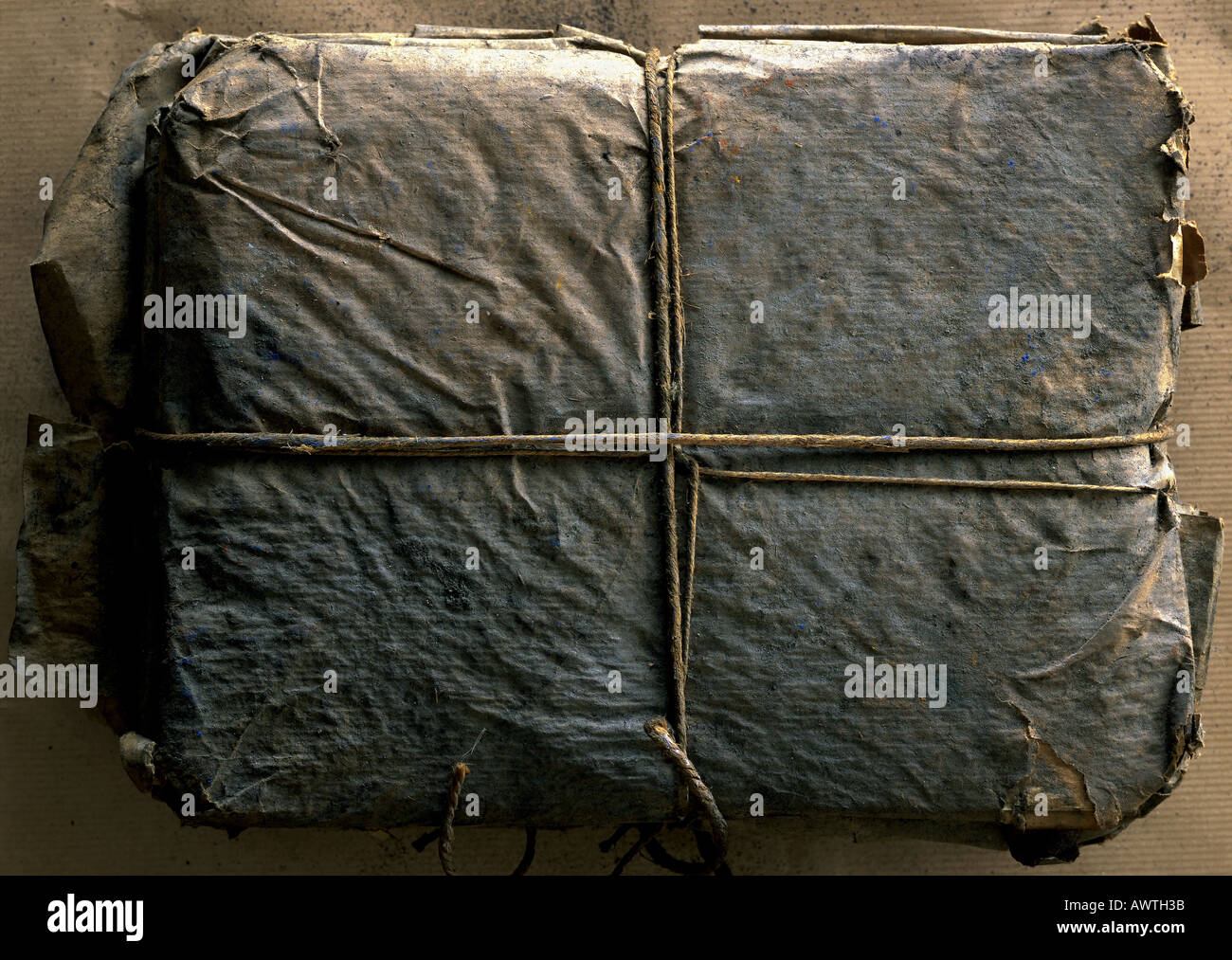 Bundle with worn edges tied in string Stock Photo - Alamy