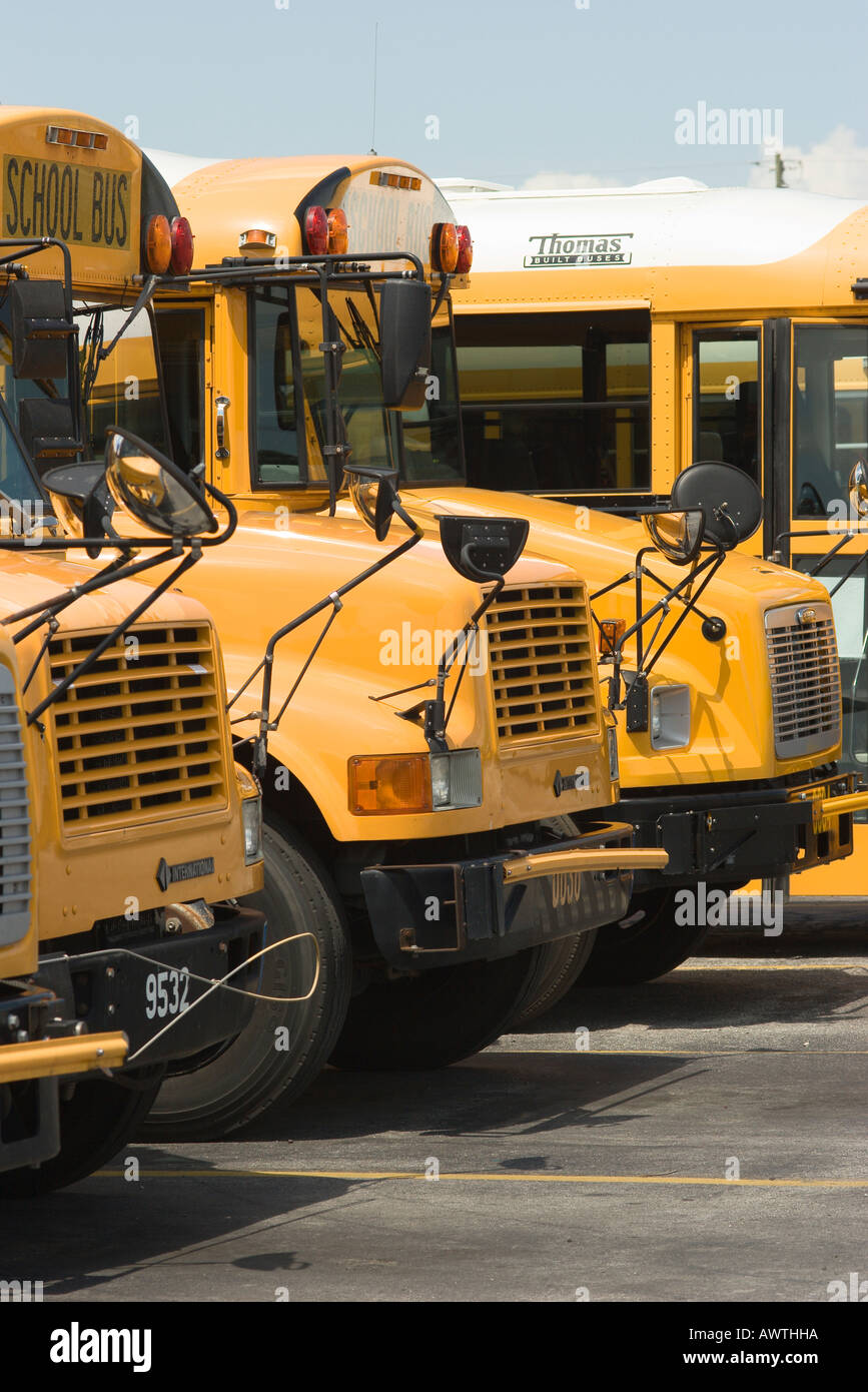 A variety of different types of school buses fill the lot waiting to be ...