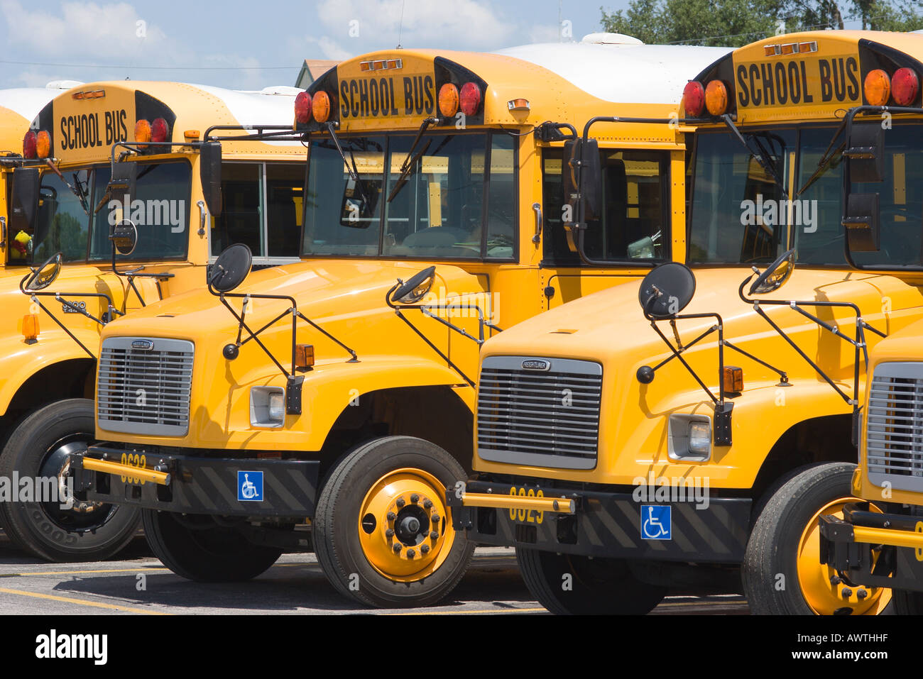 Handicap stickers on buses in the lot waiting to be dispatched to ...