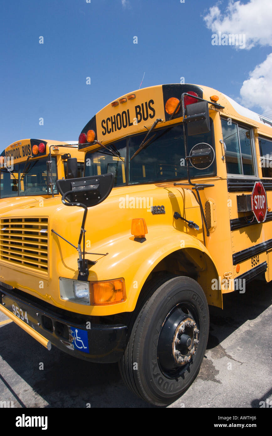 A variety of different types of school buses fill the lot waiting to be ...