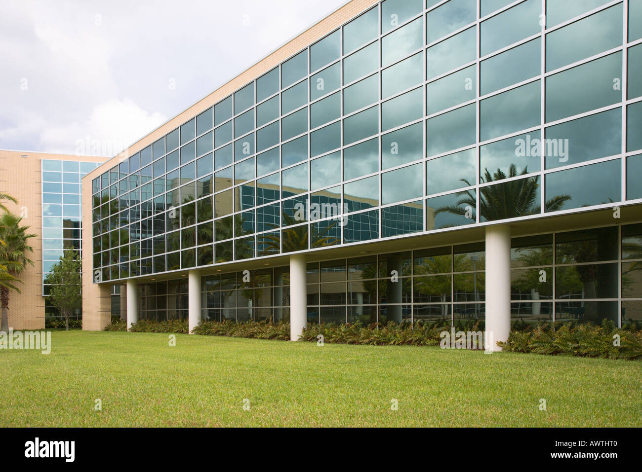 Glass building reflects cloudy sky at Central Florida Community College ...