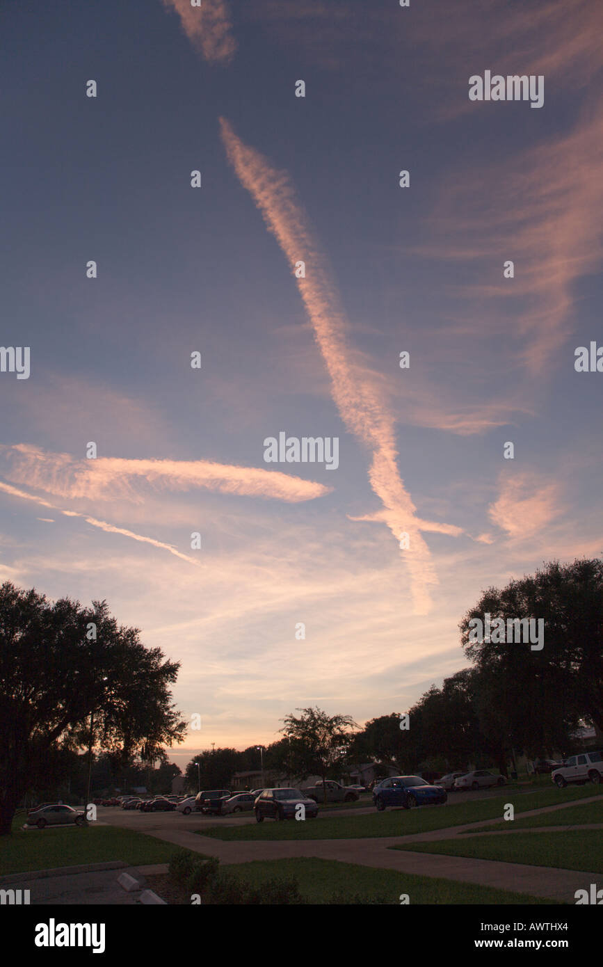 Pink jet trails in evening sky Stock Photo - Alamy