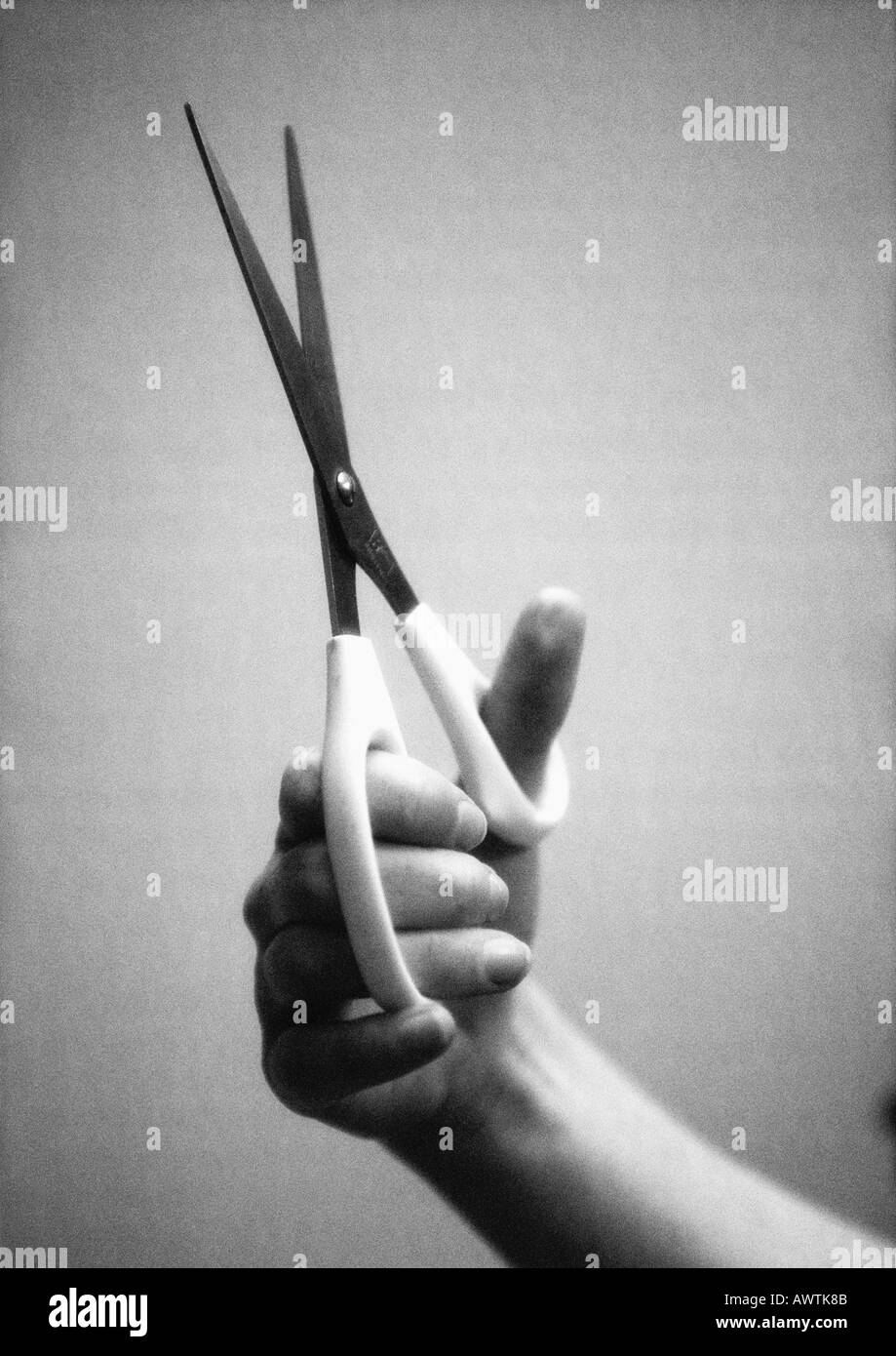 Hand holding scissors, close-up, b&w Stock Photo - Alamy