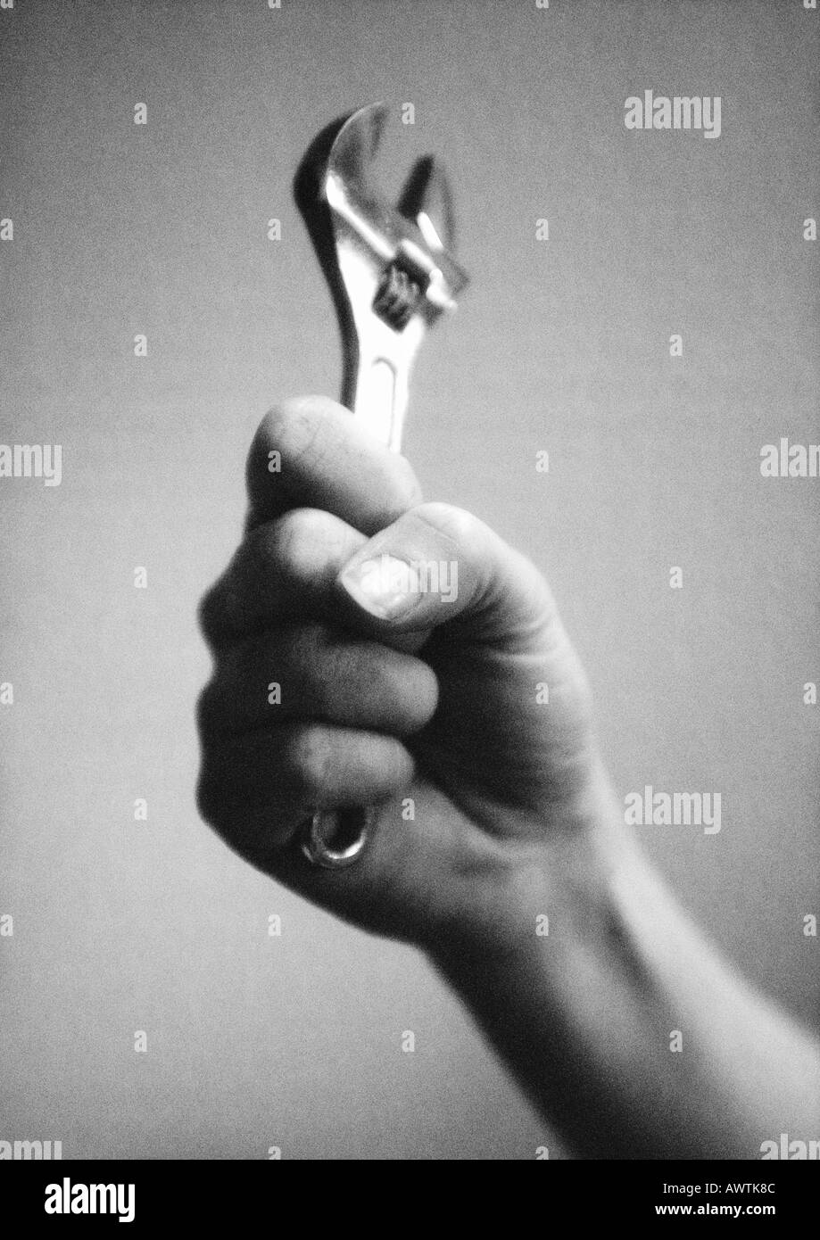 Hand holding wrench, close-up, b&w Stock Photo - Alamy