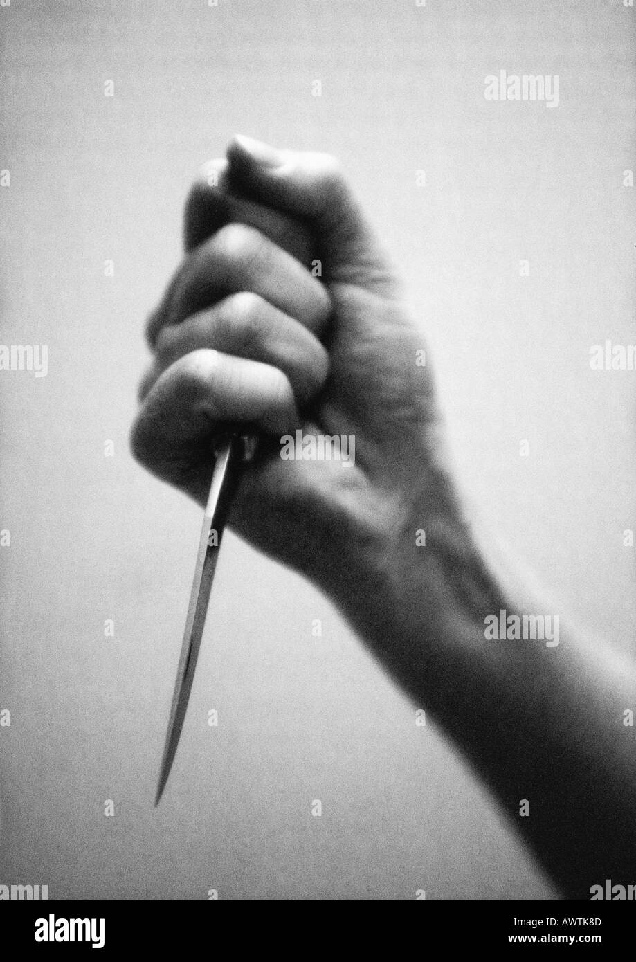 Hand holding knife, close-up, b&w Stock Photo - Alamy