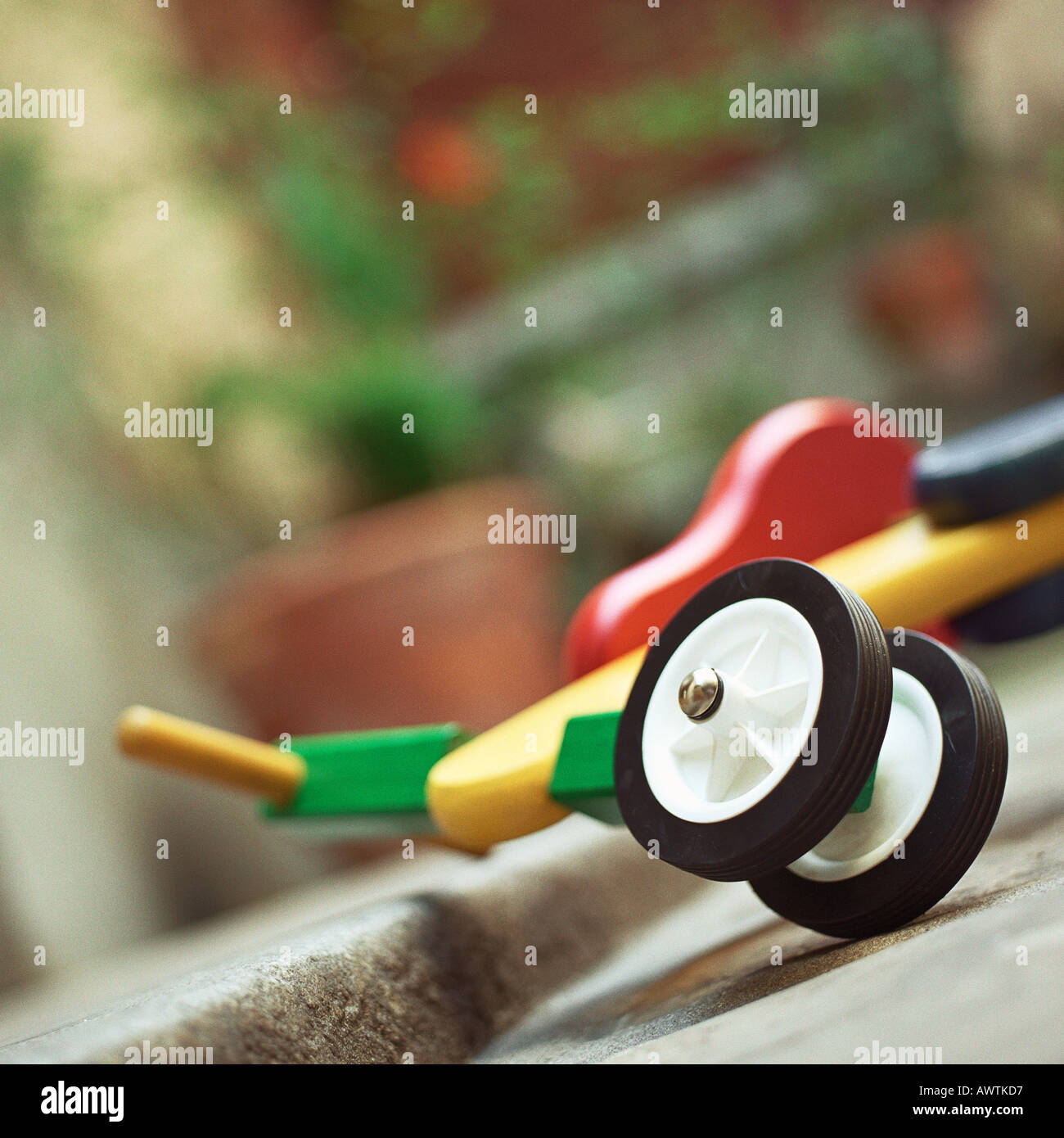 Child's toy scooter leaning on step Stock Photo - Alamy