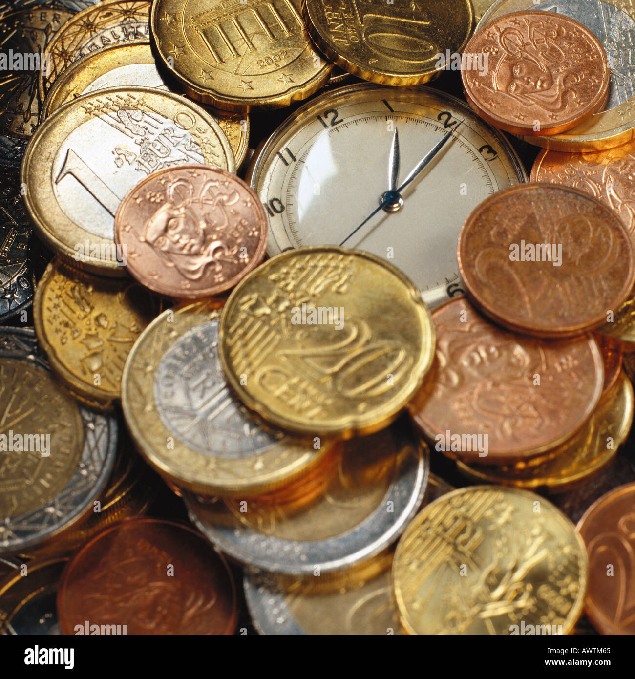 Assorted euro coins and pocket watch Stock Photo - Alamy
