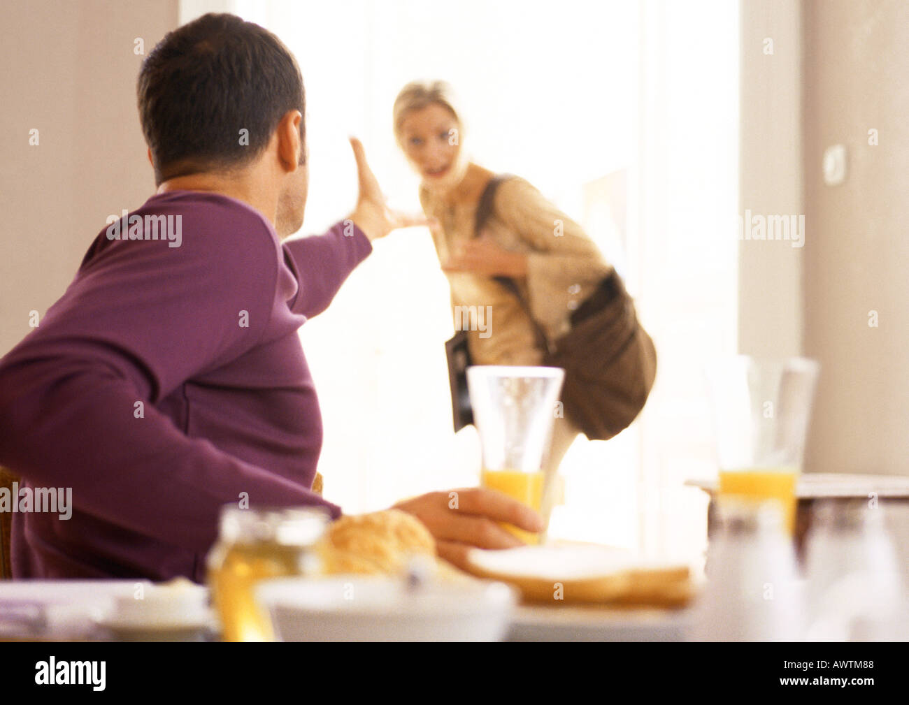 Man gesturing to woman leaving Stock Photo - Alamy