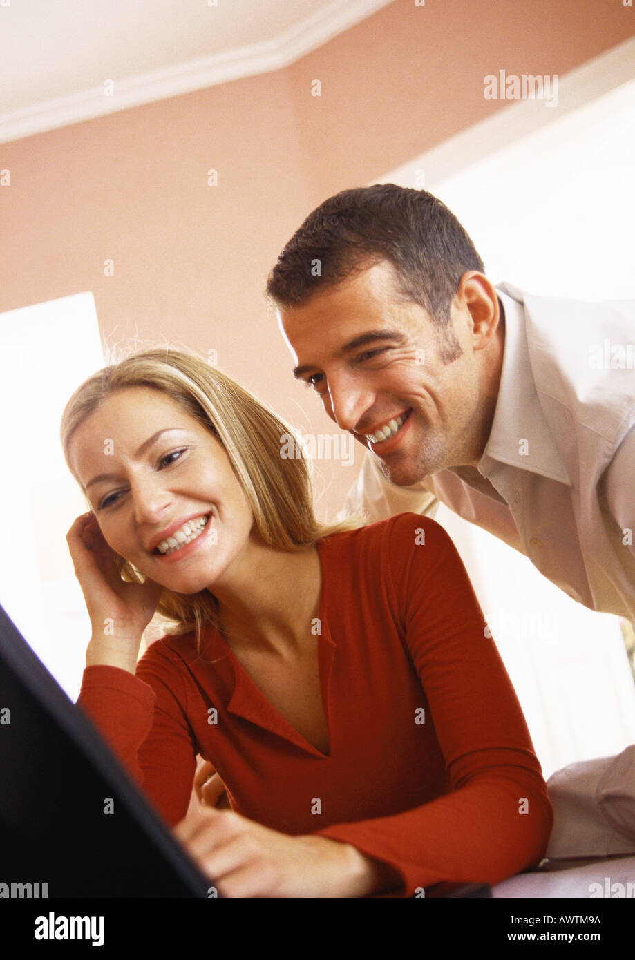 Man looking over shoulder of woman using computer Stock Photo - Alamy