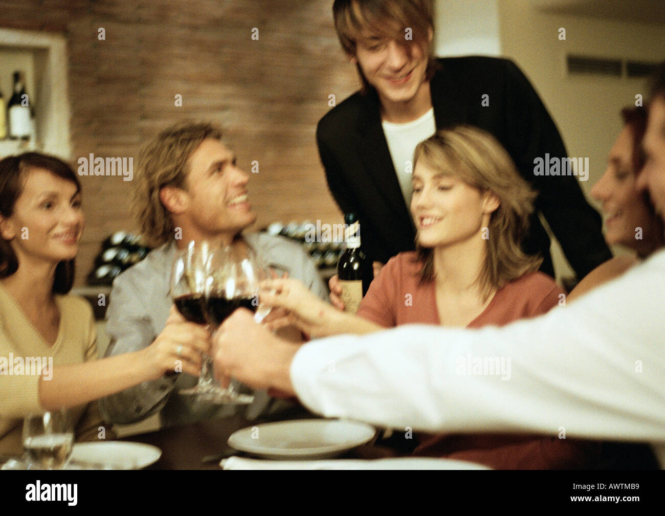 Adults sitting around dinner table hi-res stock photography and images ...