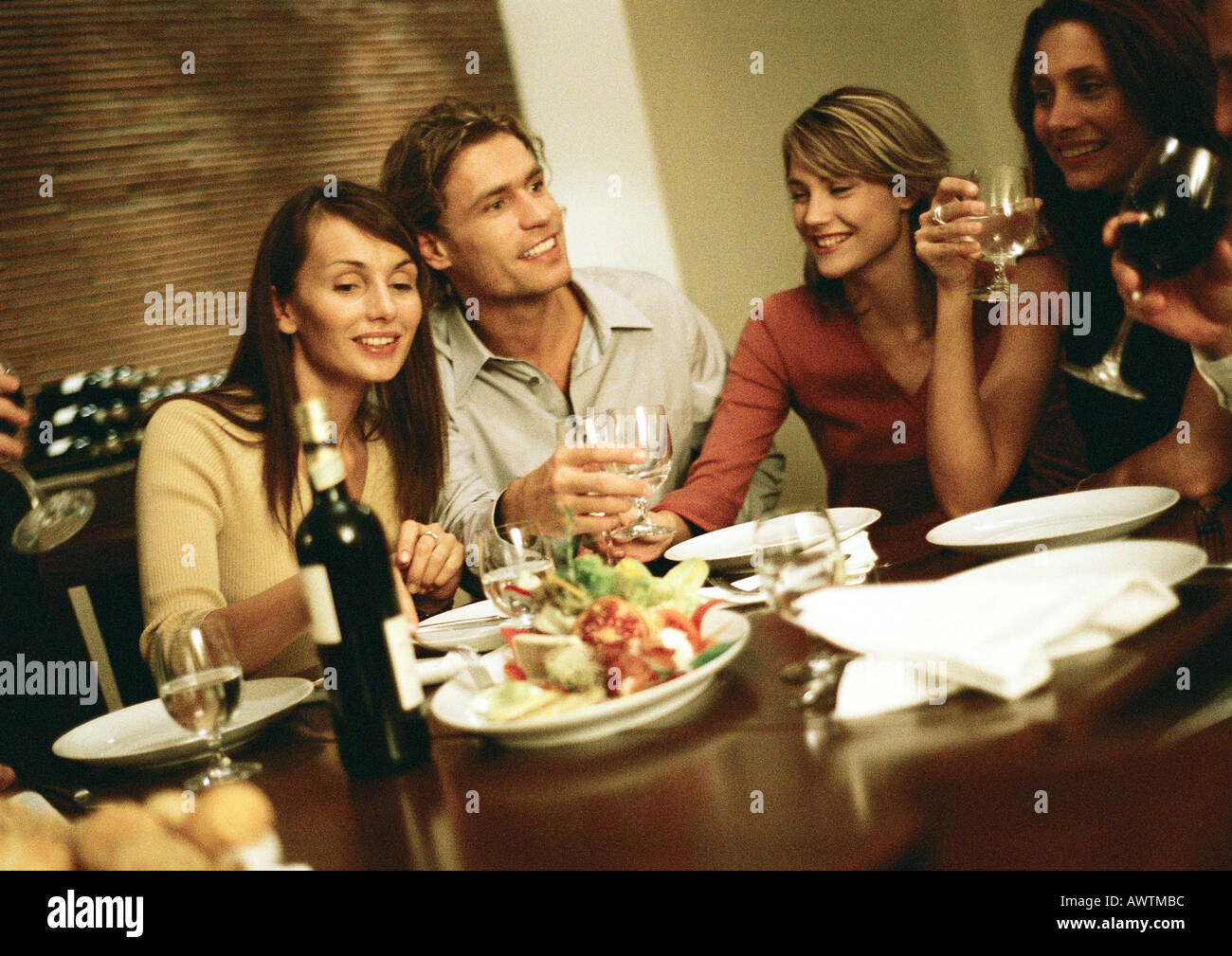 Group of young people around table, drinking Stock Photo - Alamy