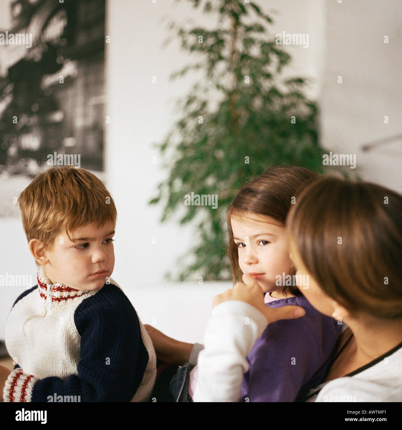 Children sitting with mother Stock Photo - Alamy
