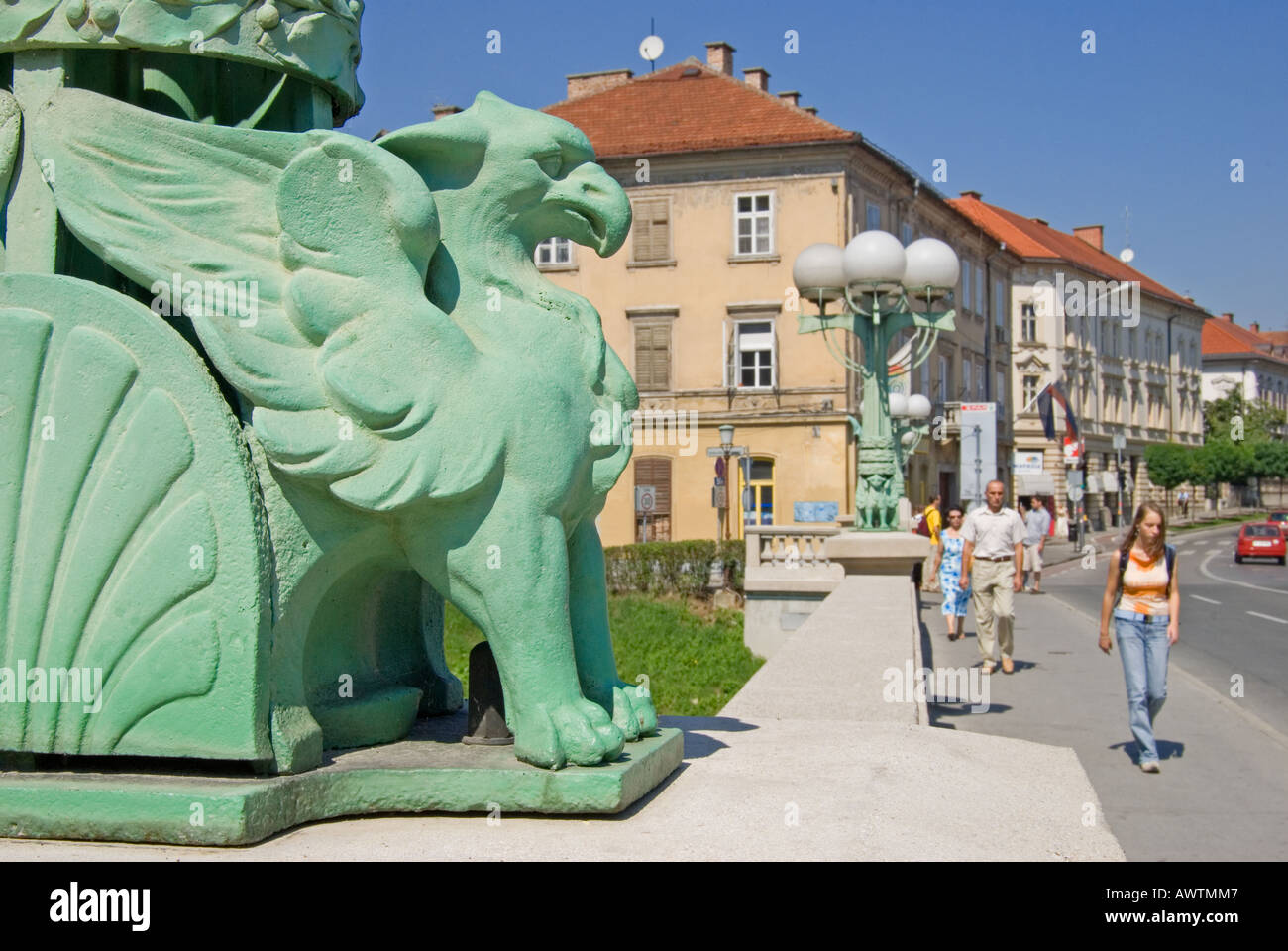 Ljubljana, Slovenia. Statue of Gryphon at base of lamp on Dragon Bridge ...