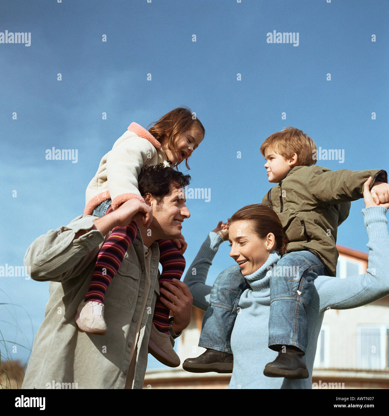 Two Boys Carrying Two Girls On Their Shoulders High Resolution Stock ...