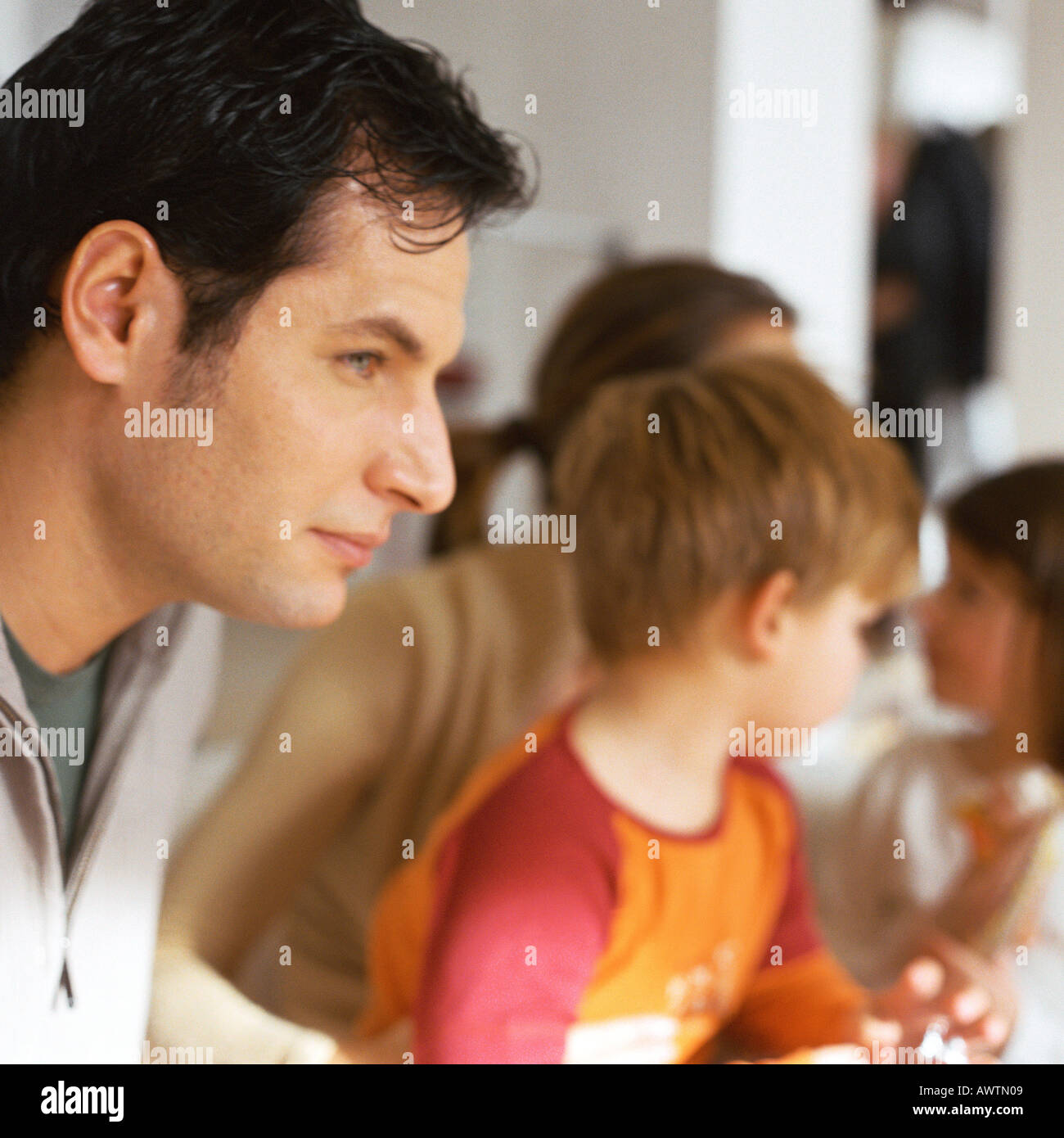 Father sitting with family, close-up Stock Photo - Alamy