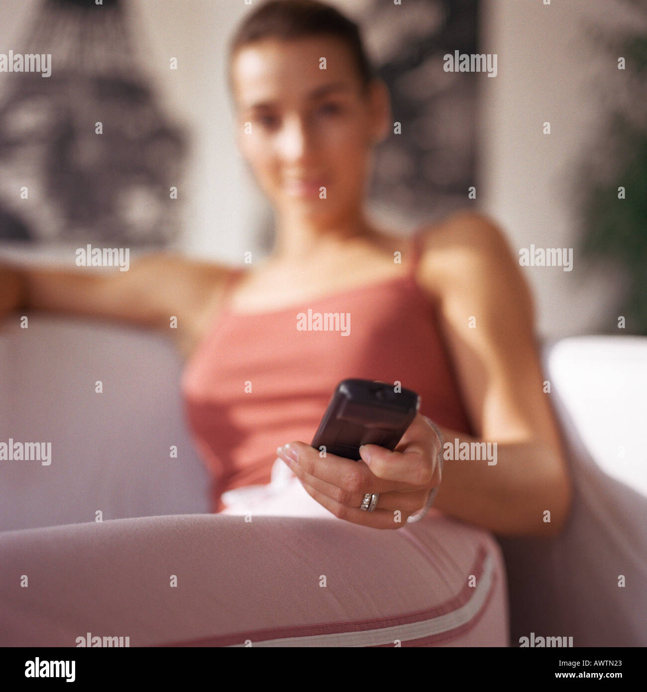 Woman holding remote control Stock Photo - Alamy