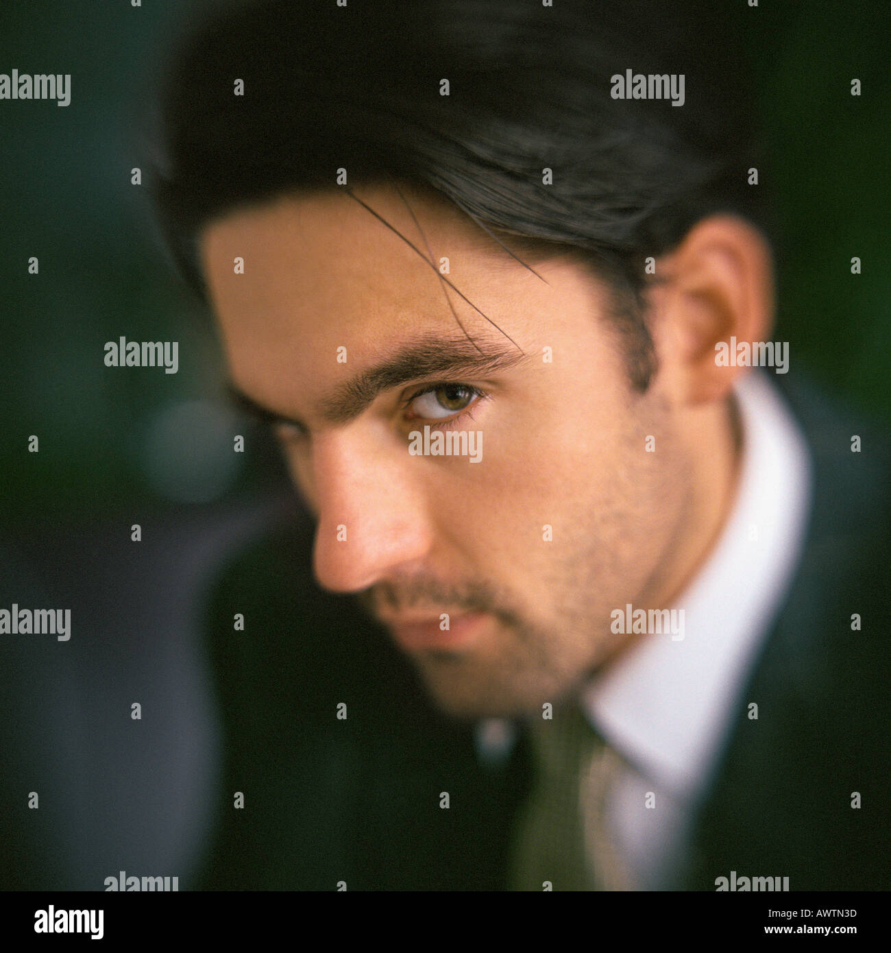 Businessman looking at camera, side view, portrait Stock Photo - Alamy