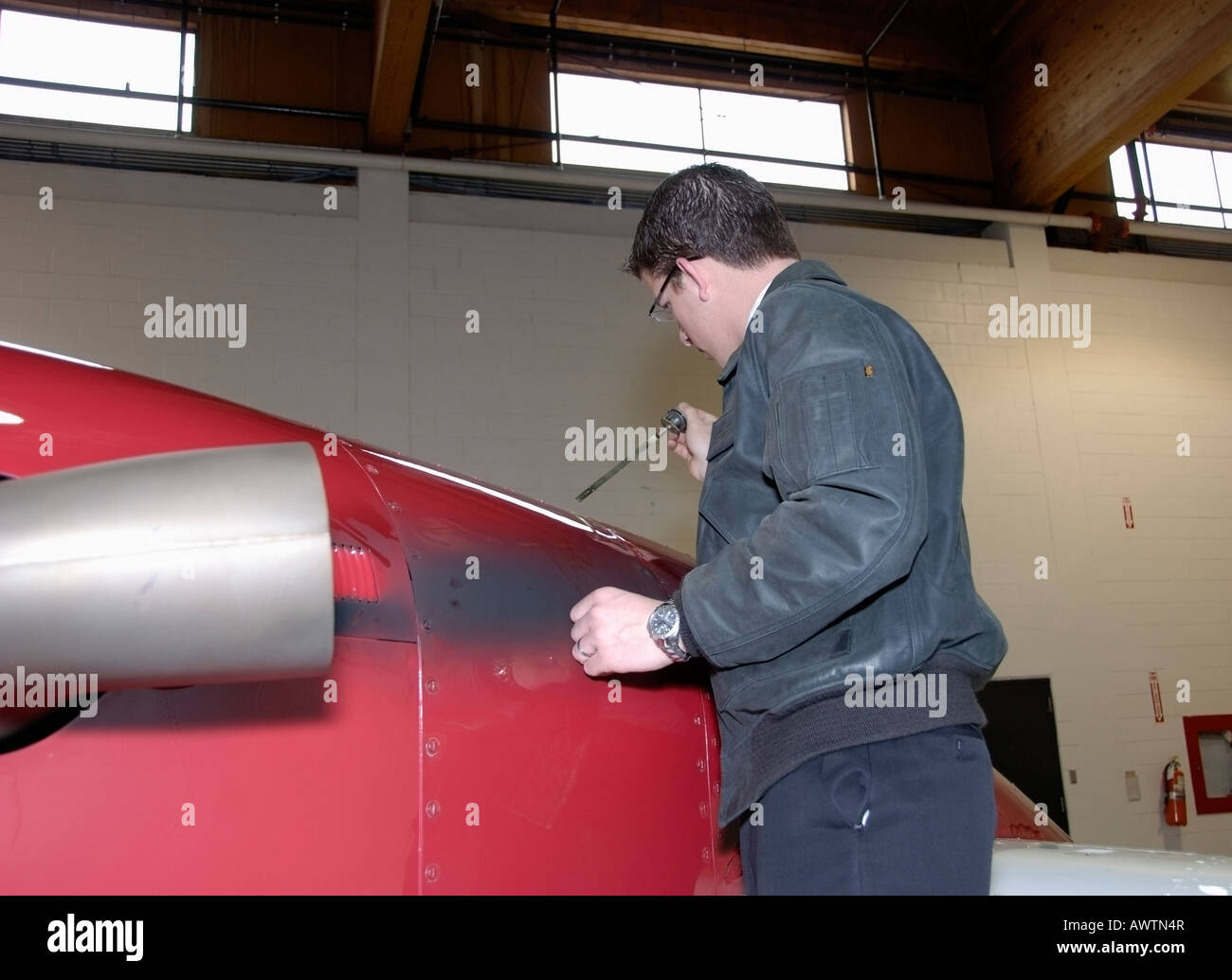 A pilot does a preflight check of the engine oil level Stock Photo - Alamy