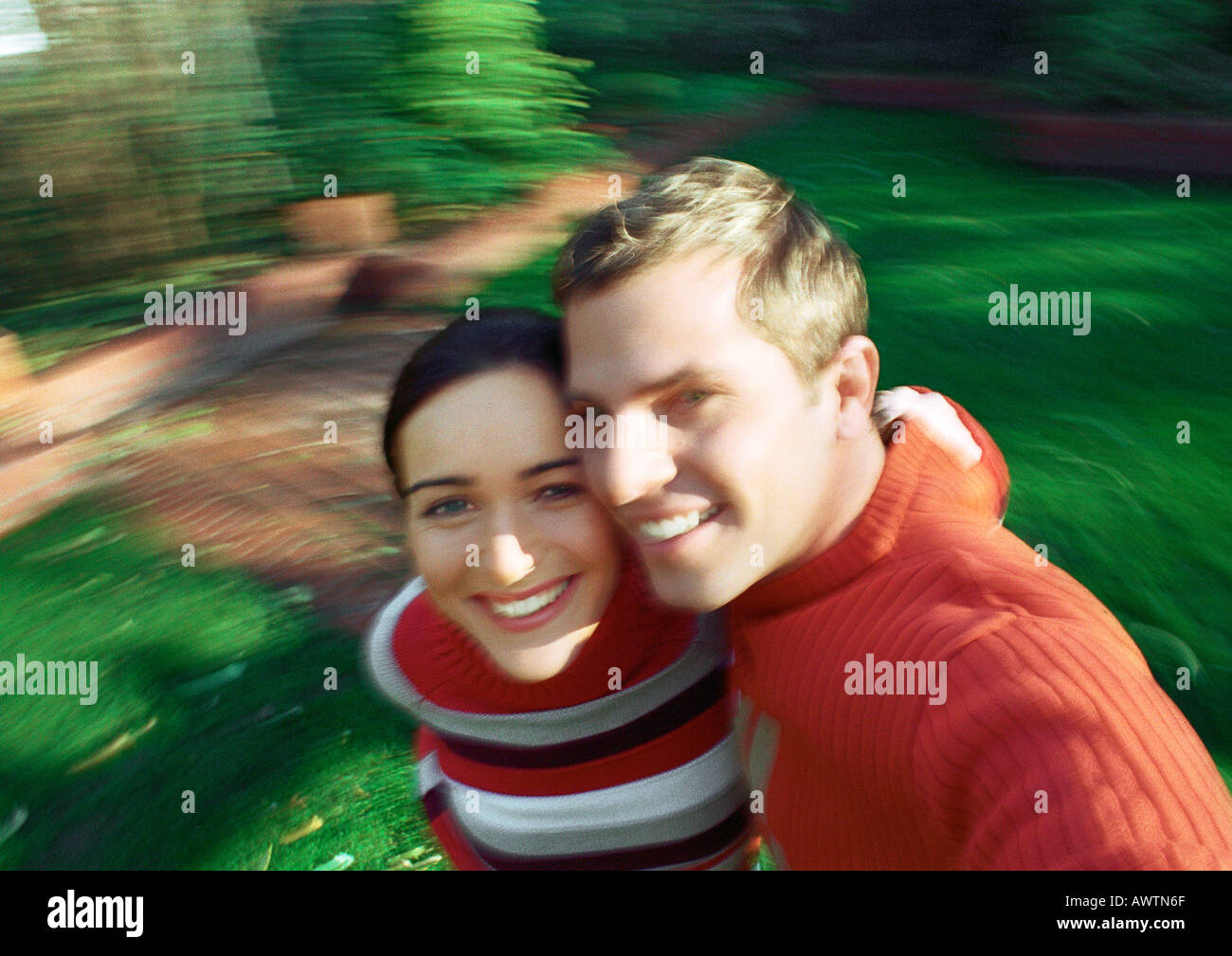 Couple smiling, cheek to cheek, blurred Stock Photo - Alamy