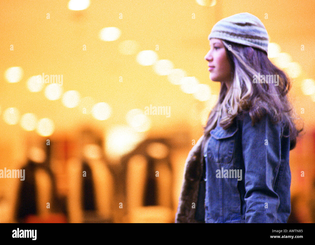 Girl walking by store window Stock Photo - Alamy