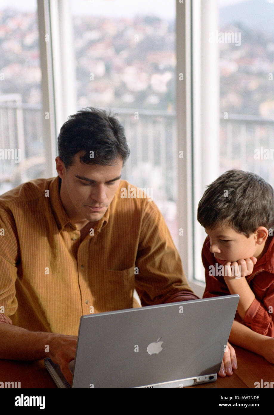 Father and son working on computer Stock Photo - Alamy