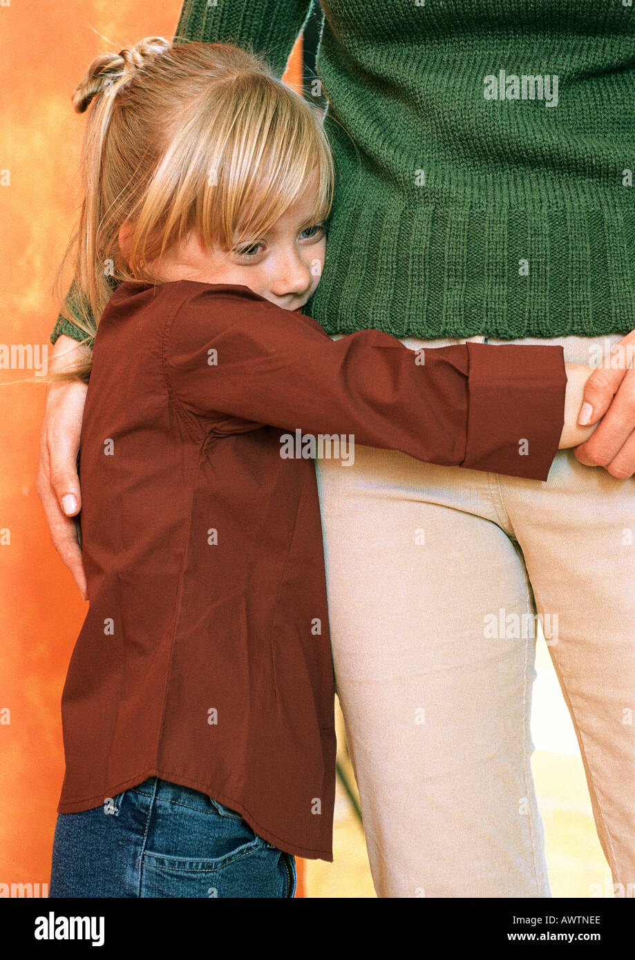 Daughter hugging mother around waist Stock Photo - Alamy
