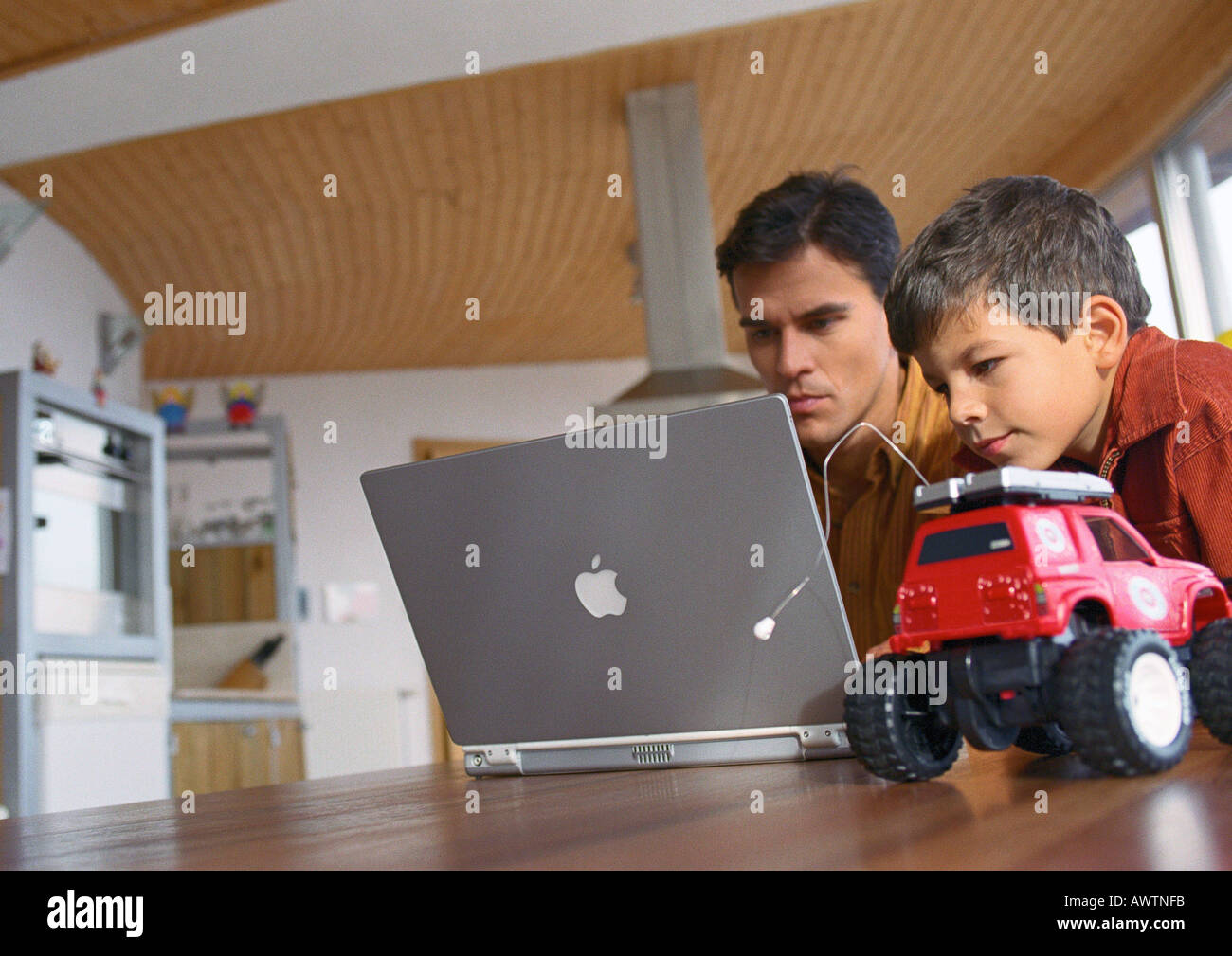 Father and son working on computer together Stock Photo - Alamy
