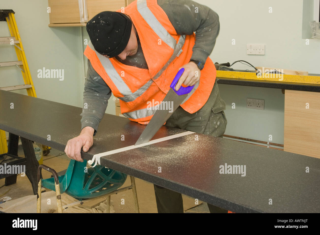 man cutting a kitchen worktop Stock Photo - Alamy